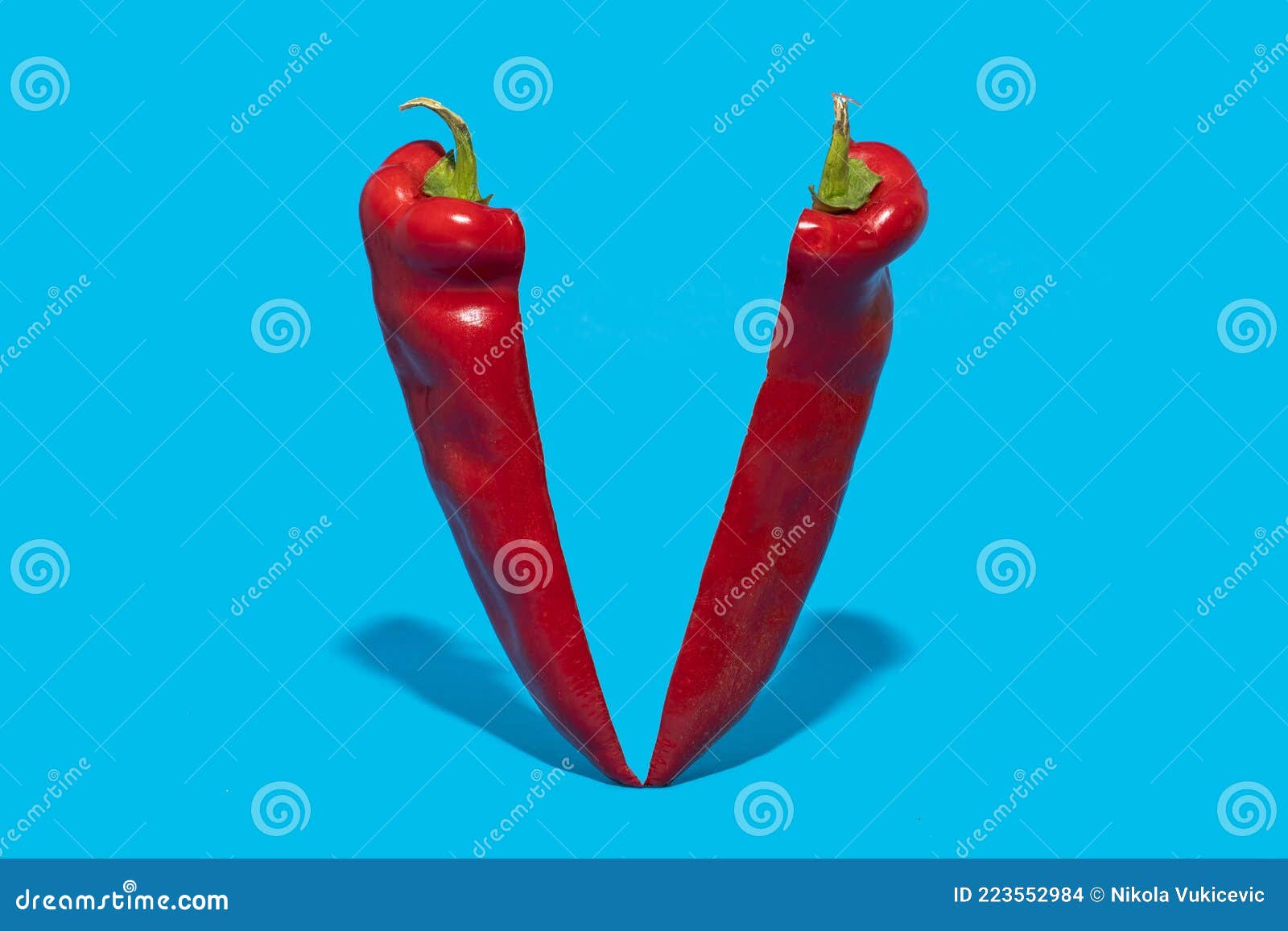 Red Pepper Split On Half Standing On Blue Background Royalty-Free Stock ...