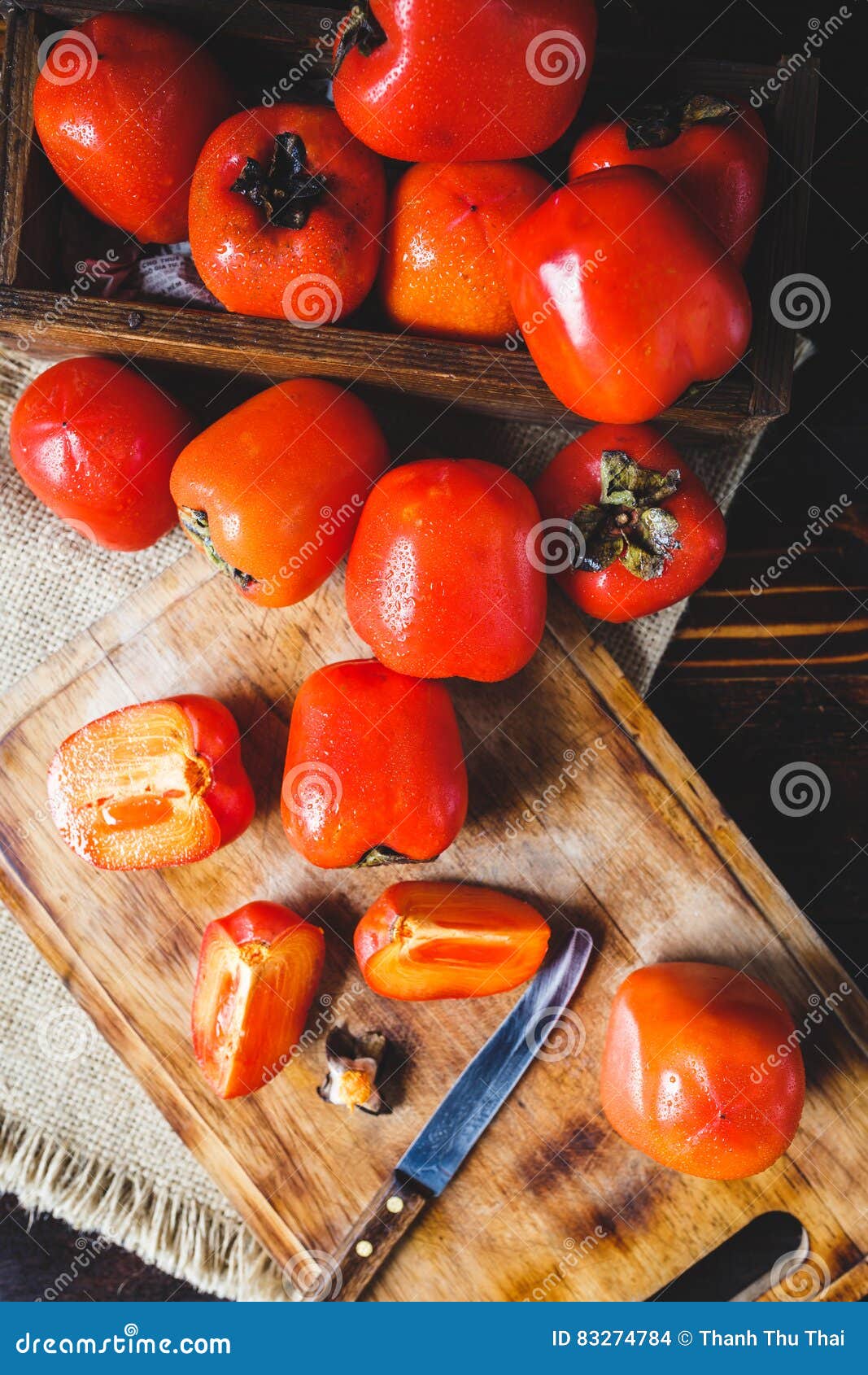 Red Persimmons stock photo. Image of cuttingboard, burlap - 83274784