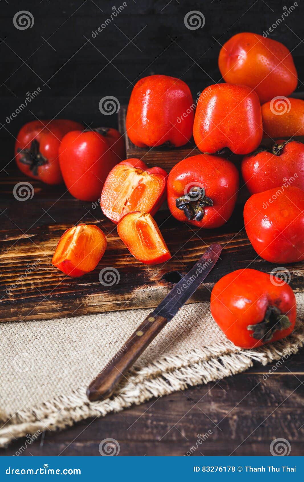 Red Persimmons stock photo. Image of wood, farm, cuttingboard - 83276178