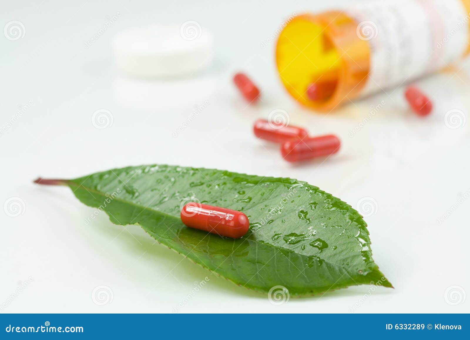 Red pill over a green leaf stock image. Image of herbal - 6332289