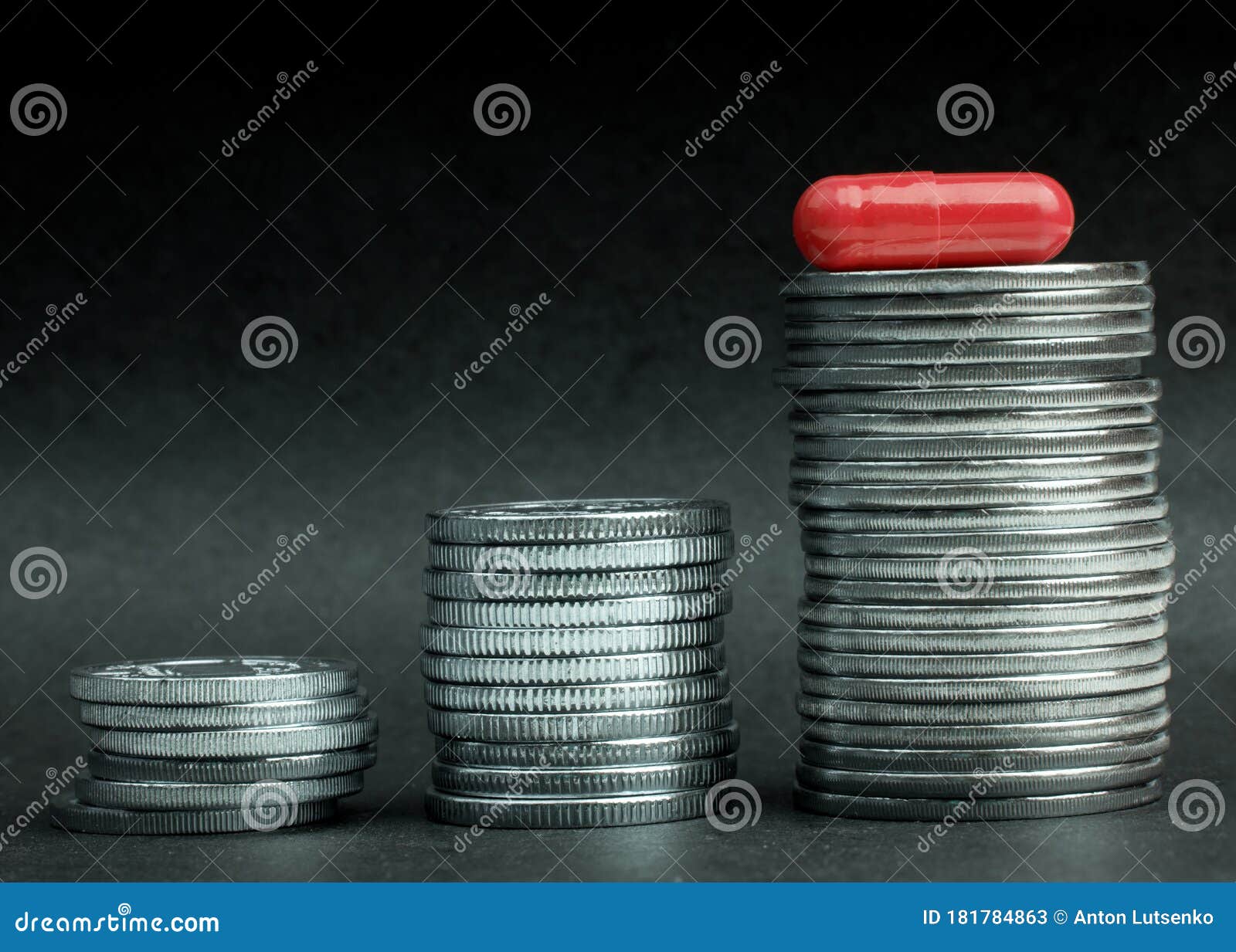 Red Pill on and Three Stacks of Coins on a Black Stock Image - Image of ...