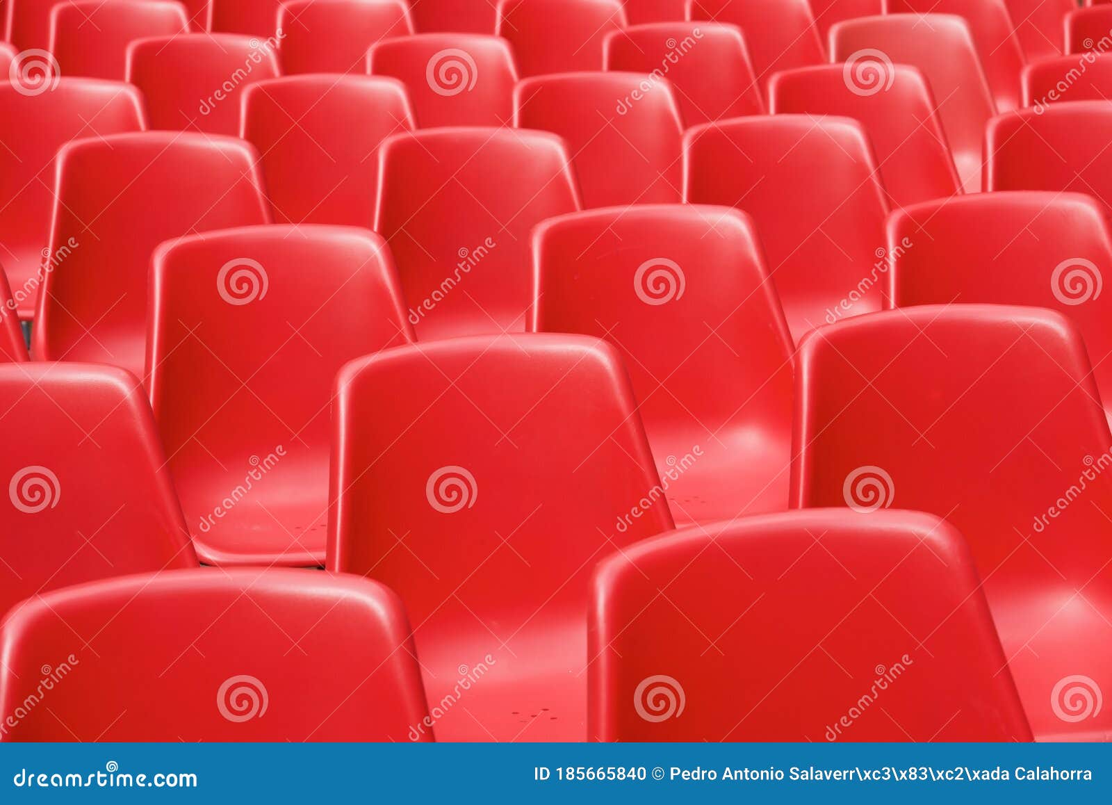 Red plastic chairs stock photo. Image of chairs, rows - 185665840