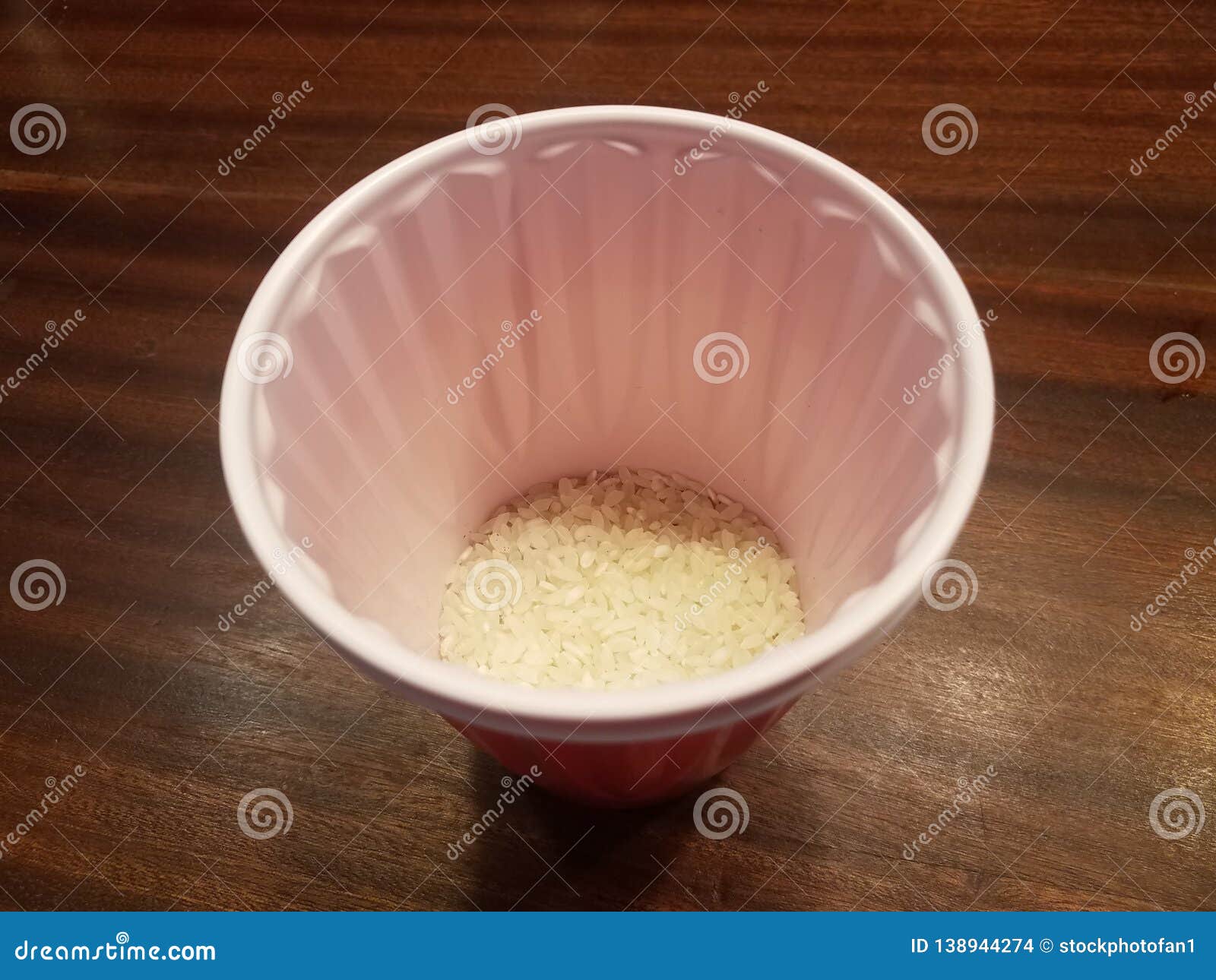 Red Plastic Cup of Rice on Brown Wood Table Stock Photo - Image of ...
