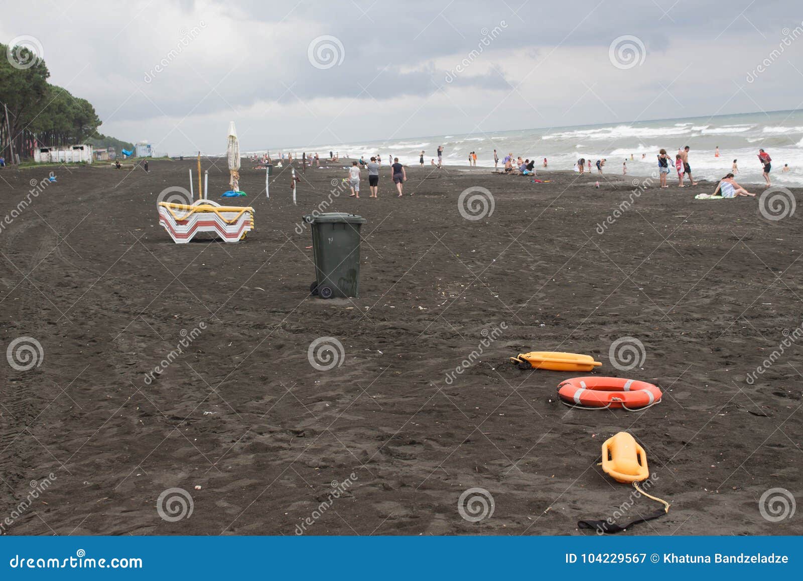 Red Plastic Floatation Rescue Devices and Sunbeds on Beach. Cloudy ...