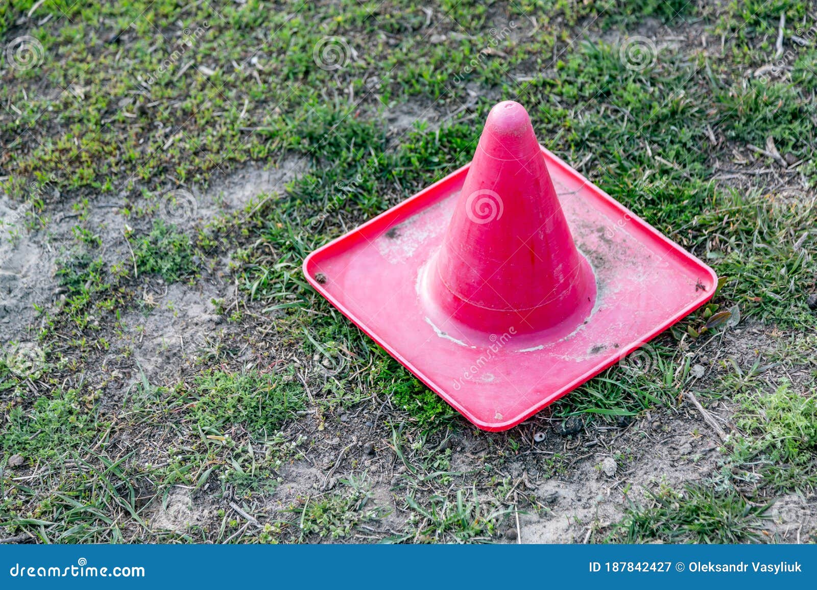 A Red Plastic Small Cone Stands on the Grass. Horizontal Orientation ...
