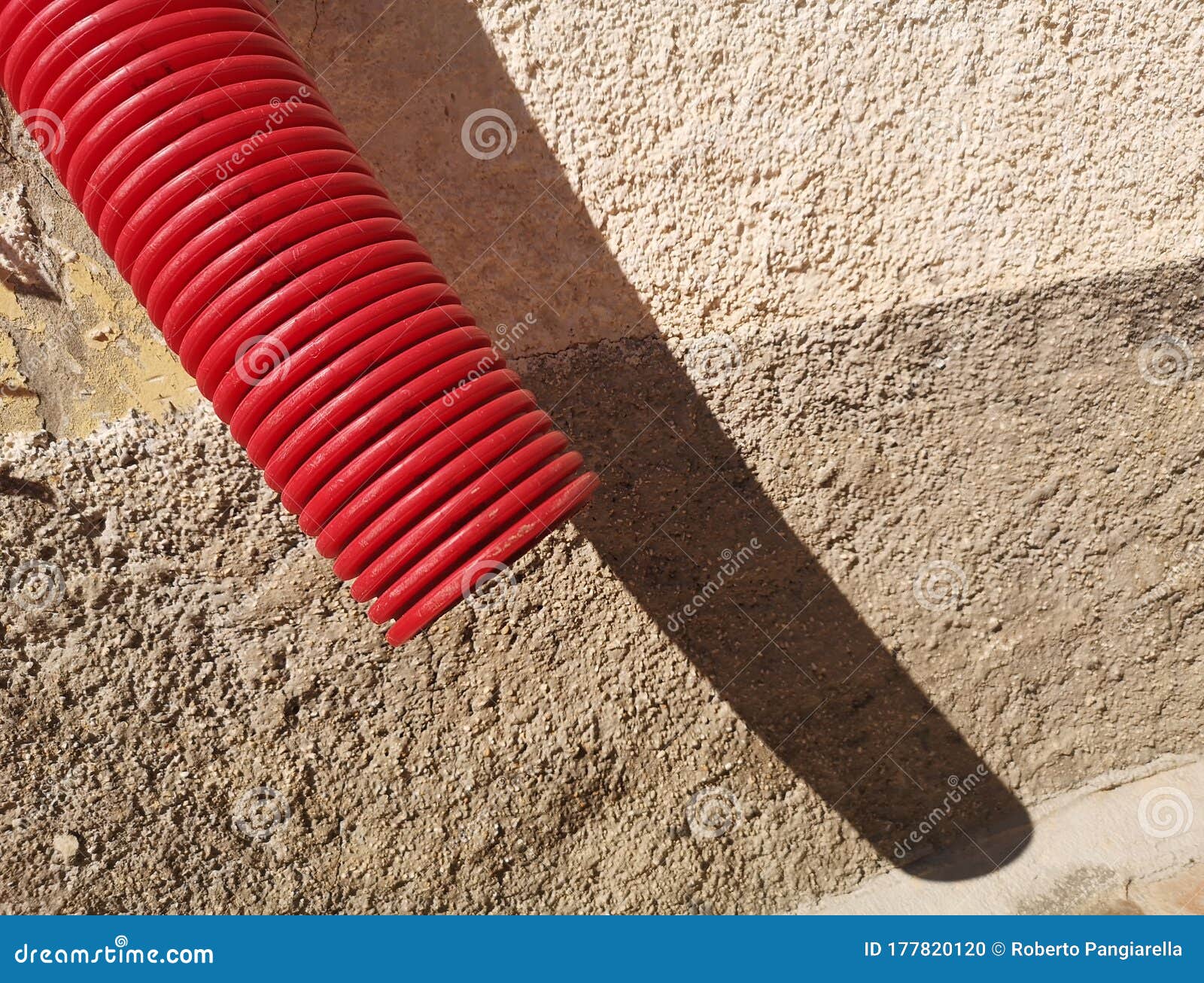 Red Plastic Tube on Construction Site Stock Photo - Image of tube ...