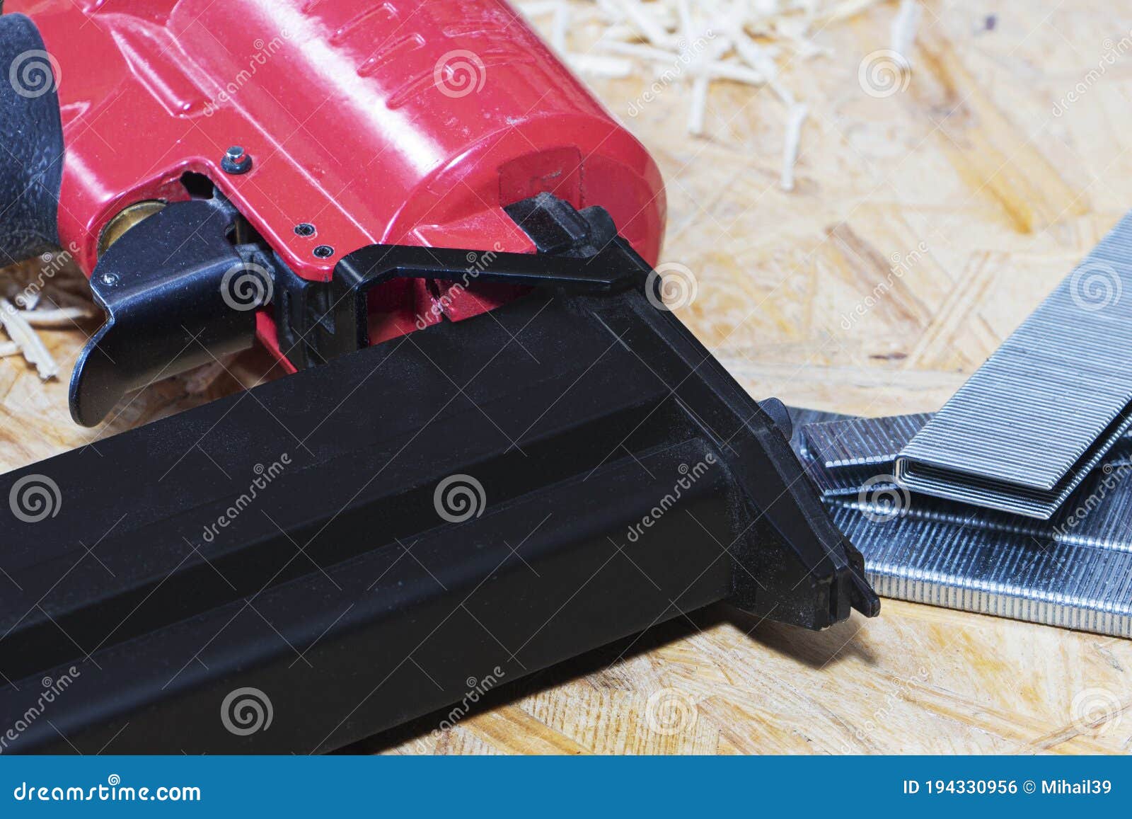 Red Pneumatic Construction Stapler and a Stack of Staples for the ...