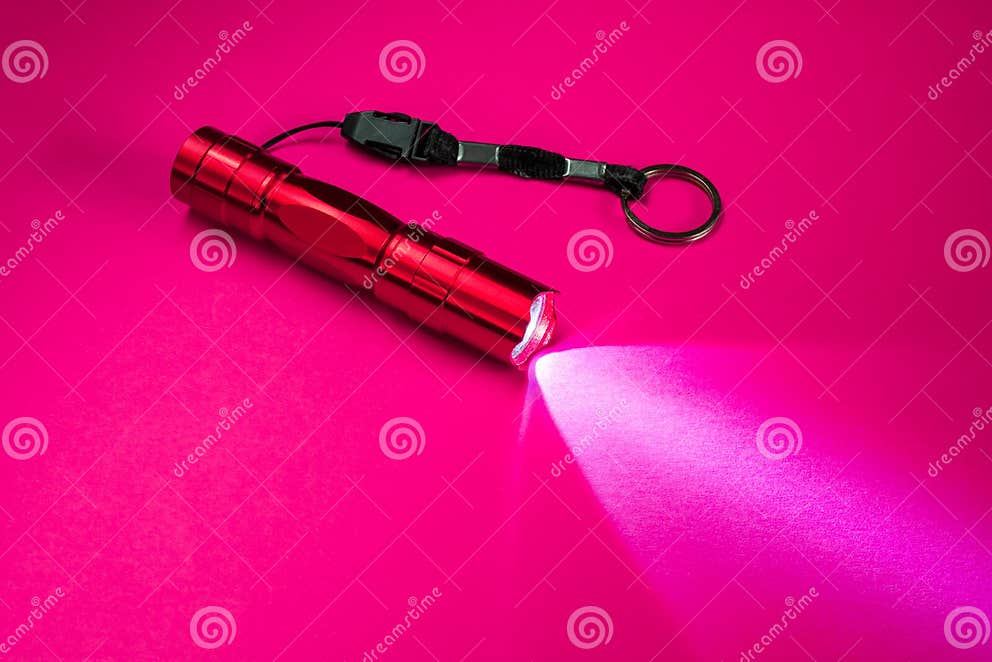 Red Pocket Flashlight on a Red Surface Stock Image - Image of clasp, illuminated: 263897303