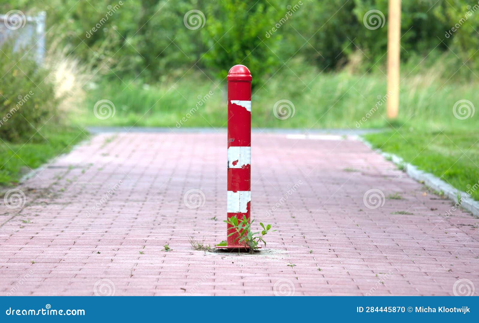 Red Pole in the Middle of a Bicycle Path Stock Photo - Image of stone ...
