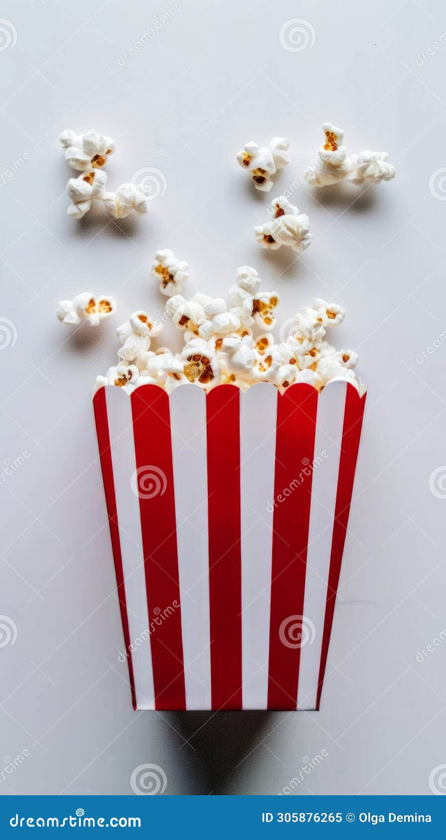 A Red Popcorn Box with Scattered Kernels on a White Background ...