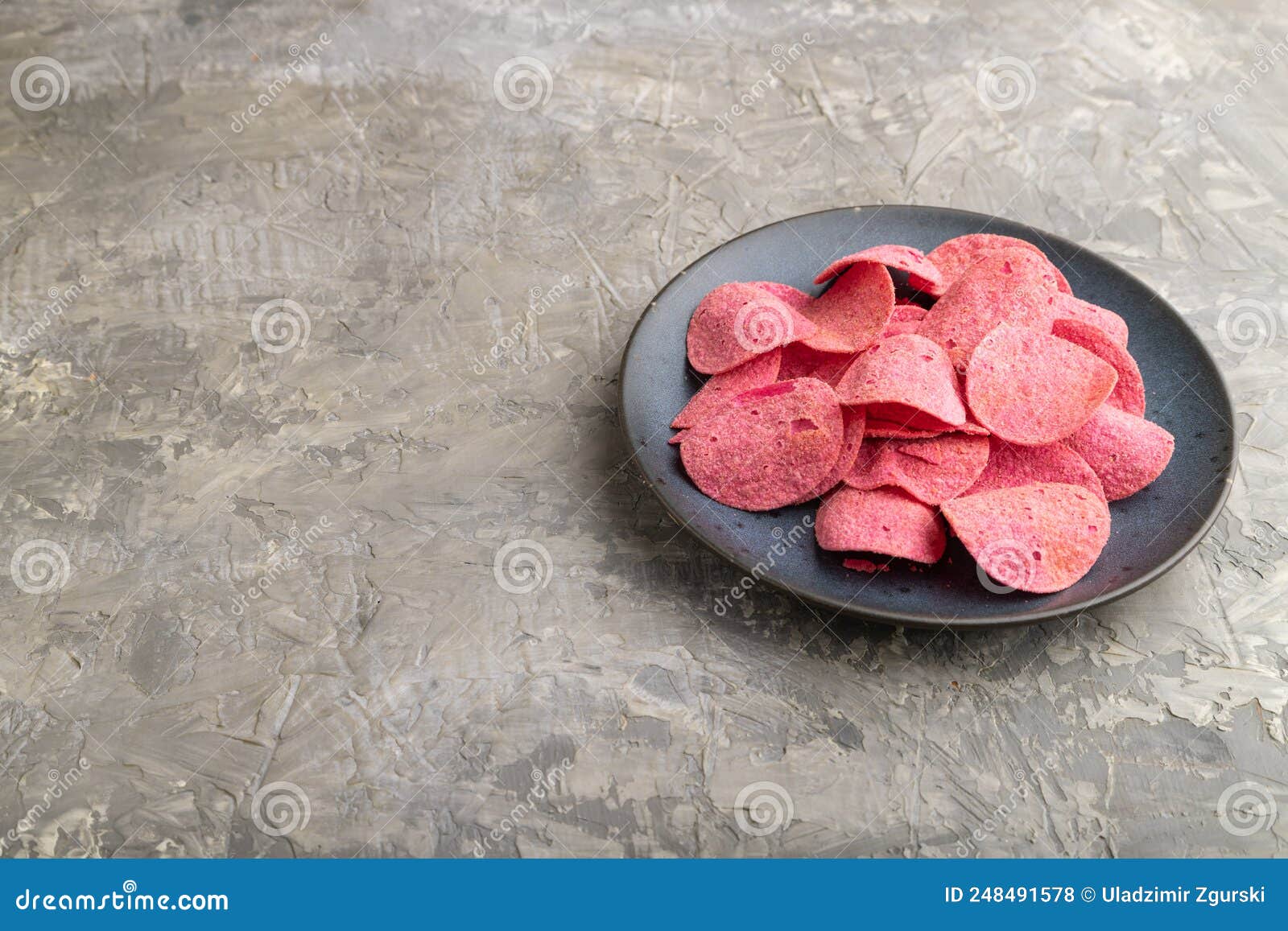 Red Potato Chips on Gray Concrete Background. Side View, Copy Space ...