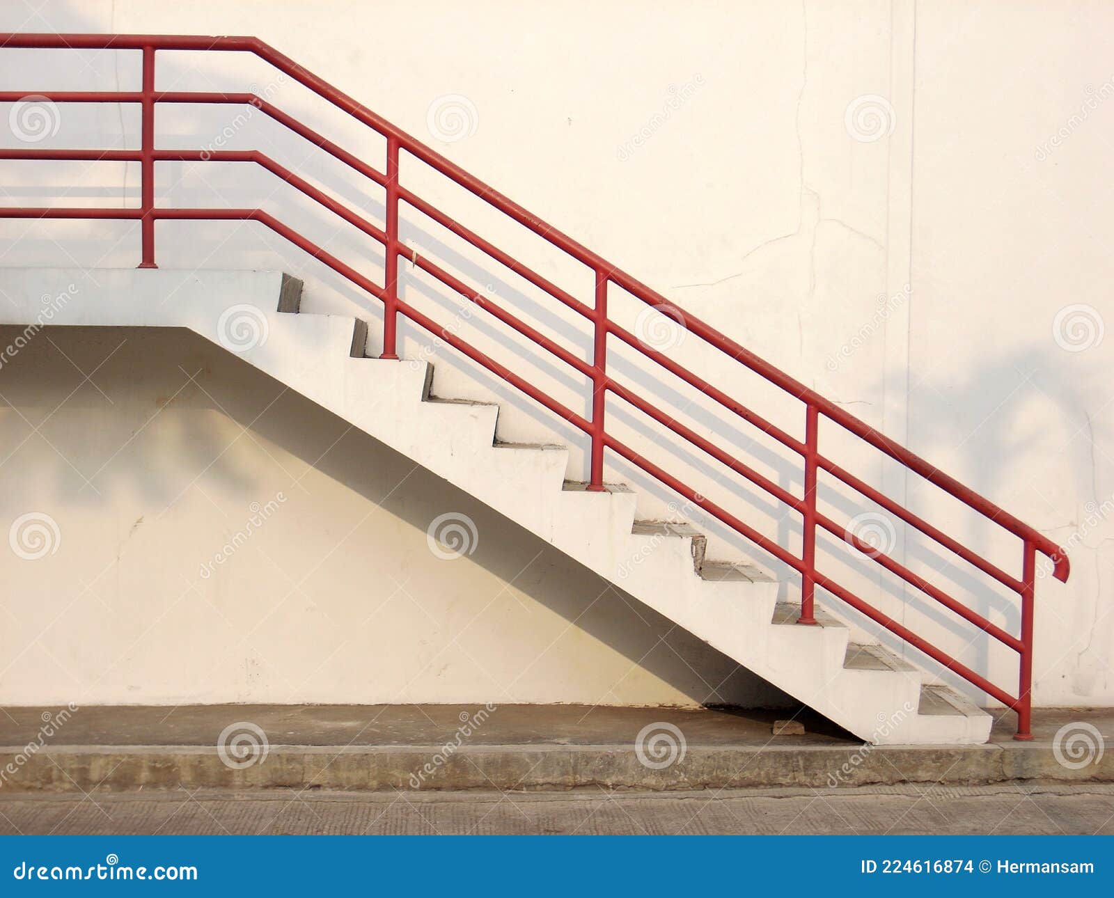 Red Railing Stairs in Front of White Wall Stock Photo - Image of ...