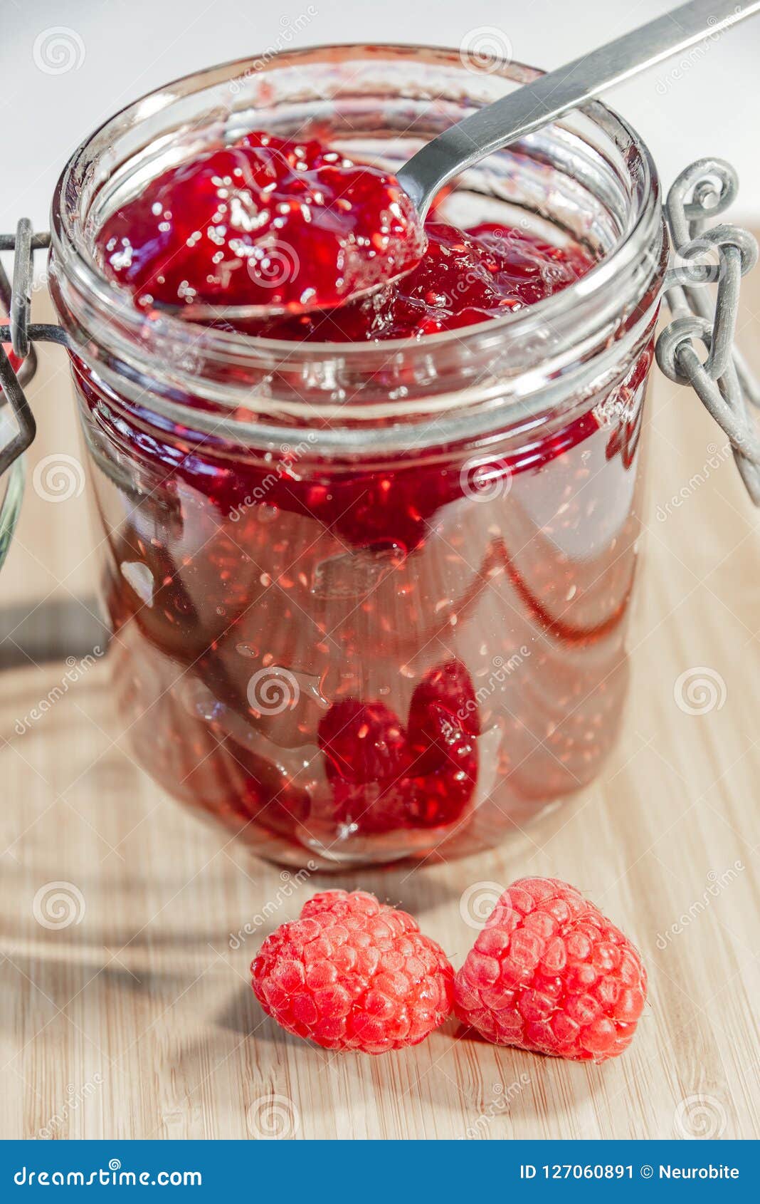 Red Raspberry Jam in Glass and Fresh Raspberries with a Spoon Stock ...