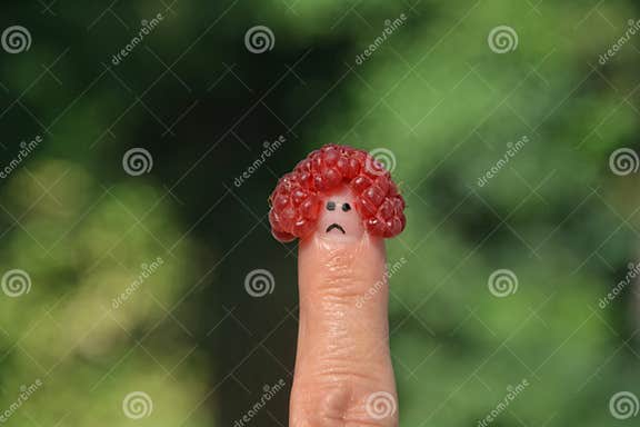 Red Raspberry on the Thumb with a Sad Face Stock Image - Image of poor ...