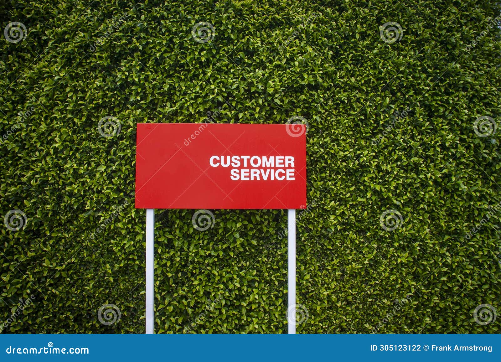 A Red Rectangular Customer Service Sign on White Poles with White ...