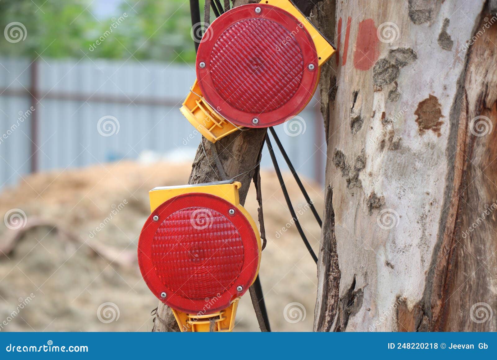 Red Reflectors are Attached To a Wooden Log by the Side of a ...