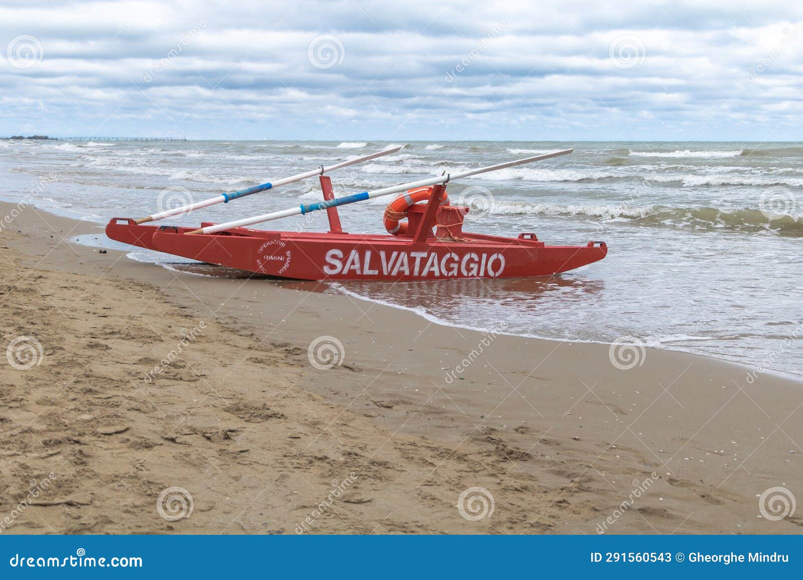 A Red Rescue Boat with Two Oars on the Beach Stock Image - Image of ...