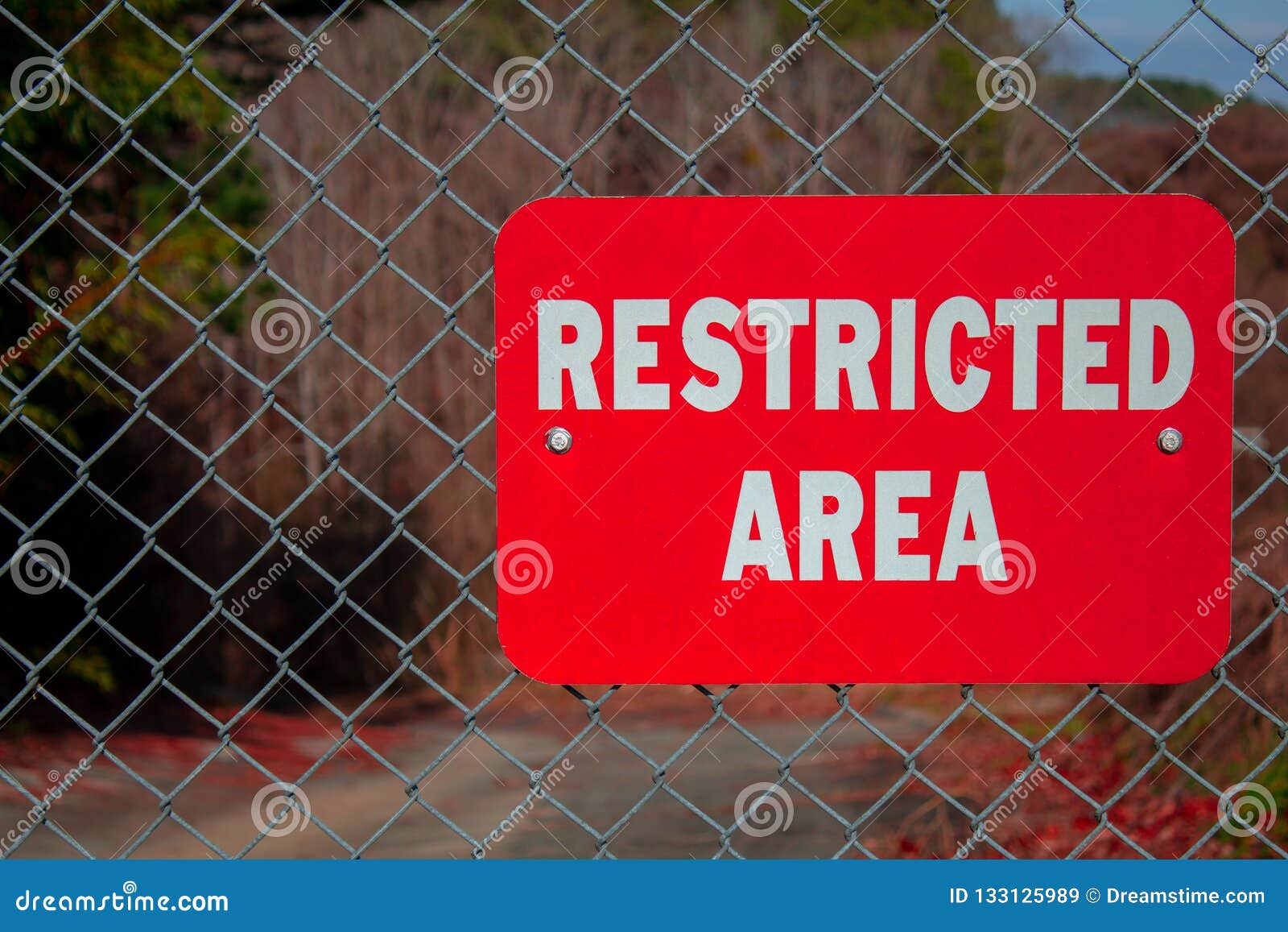 Red Restricted Area Sign on a Chain Link Fence Stock Image - Image of ...