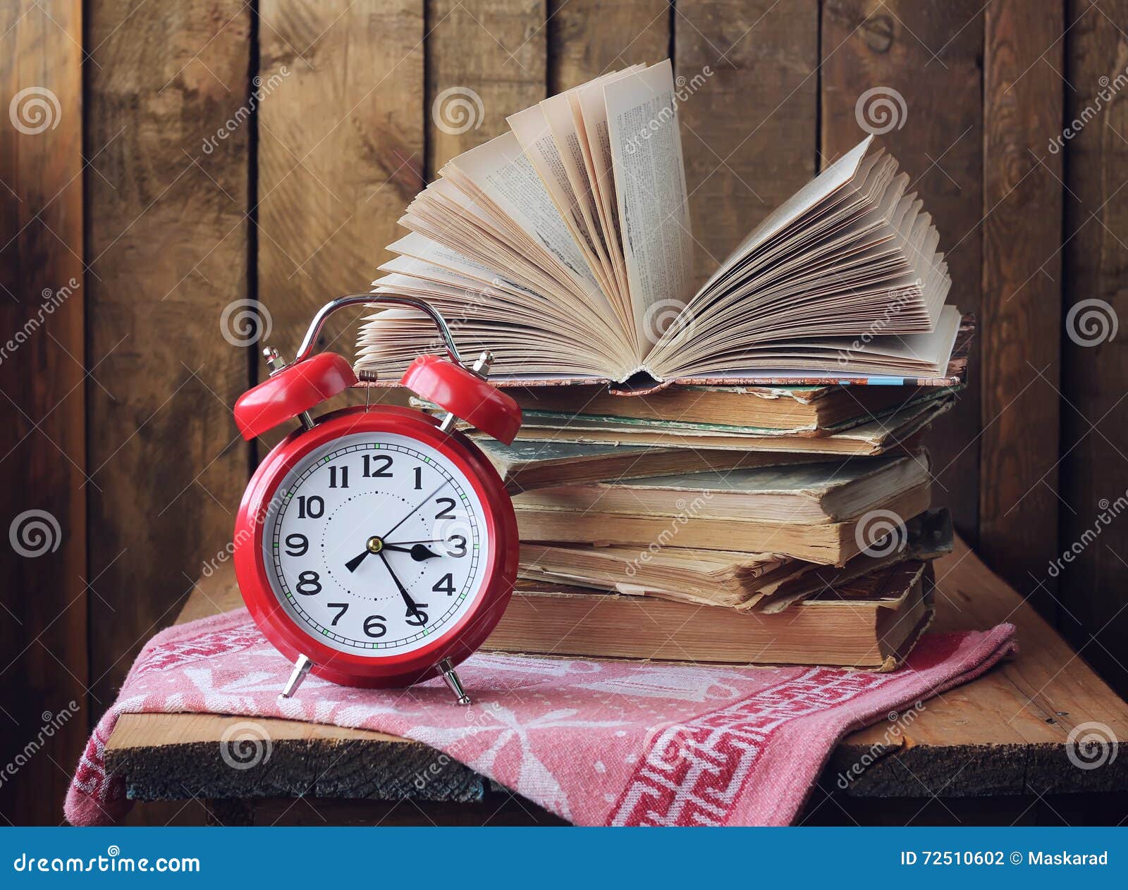 Red Retro Alarm Clock and a Stack of Books on the Table. Stock Photo ...