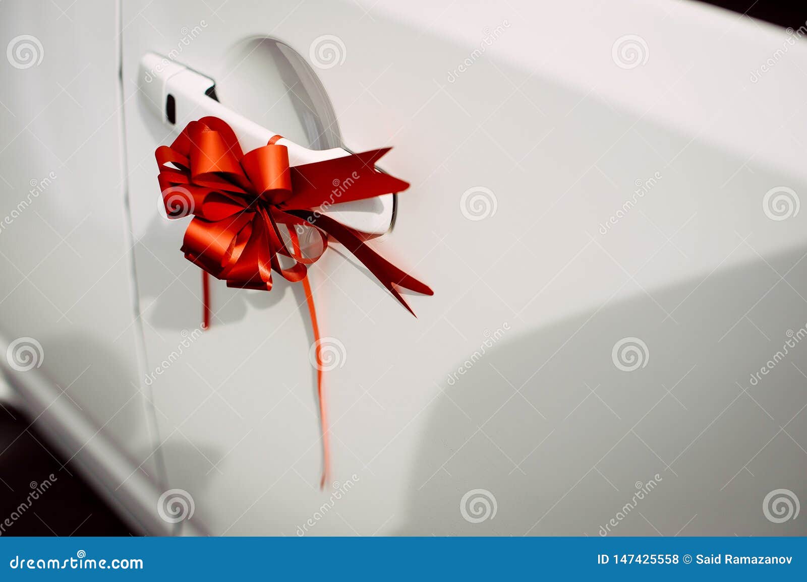 Red Ribbon Bow on the Door Handle of a White Car Stock Photo - Image of ...