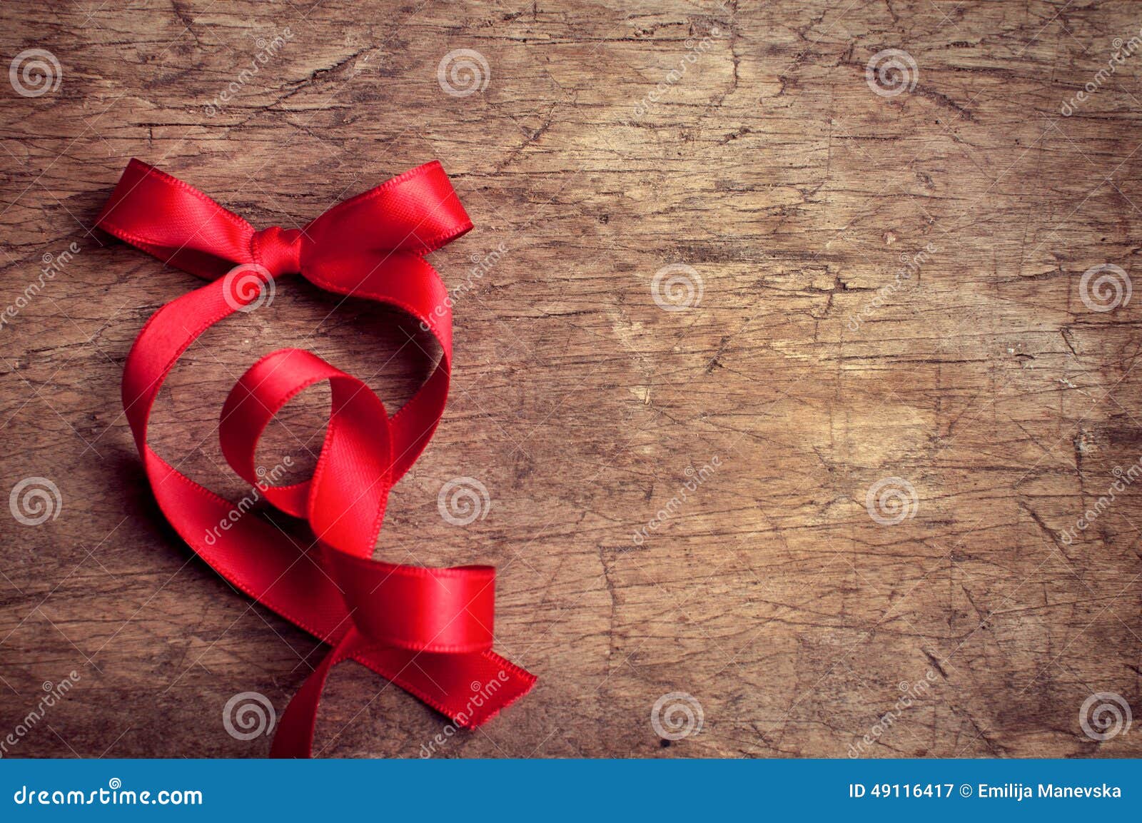 Red ribbon on wooden table stock image. Image of textured - 49116417
