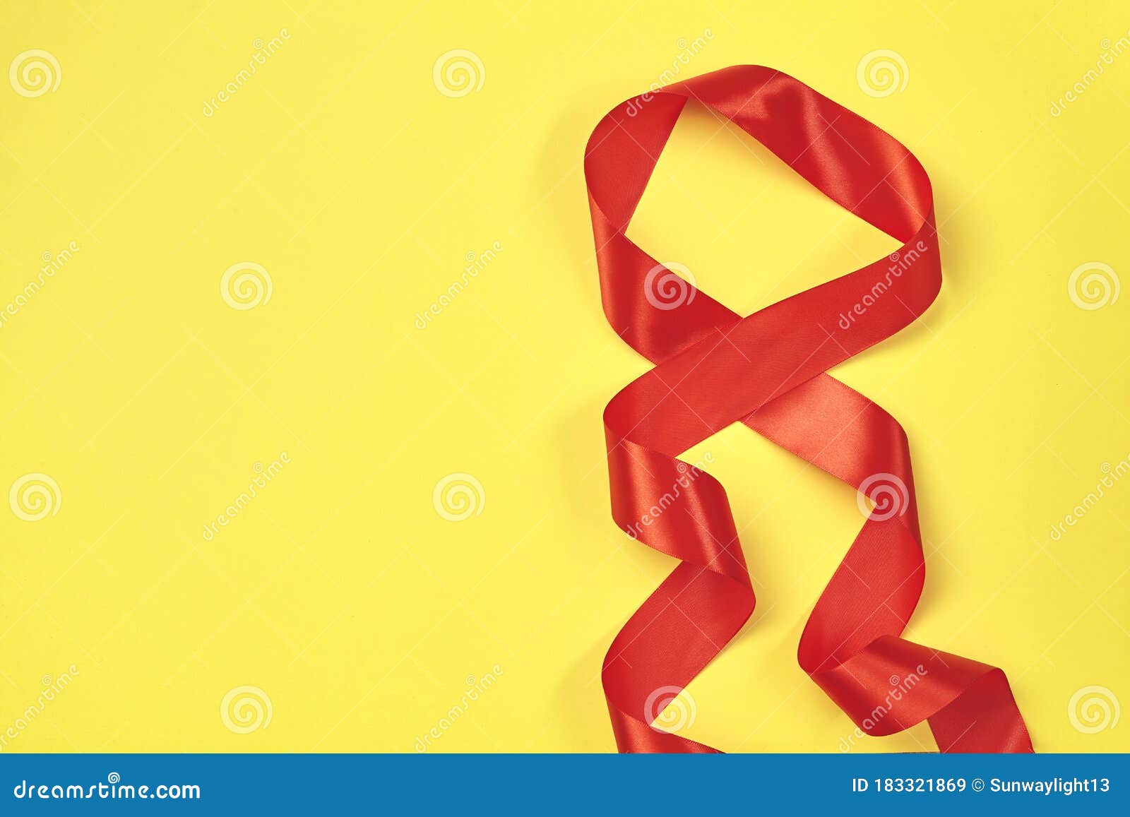 Red Ribbon on Yellow Baclground with Copy Space. Top View. Stock Image ...