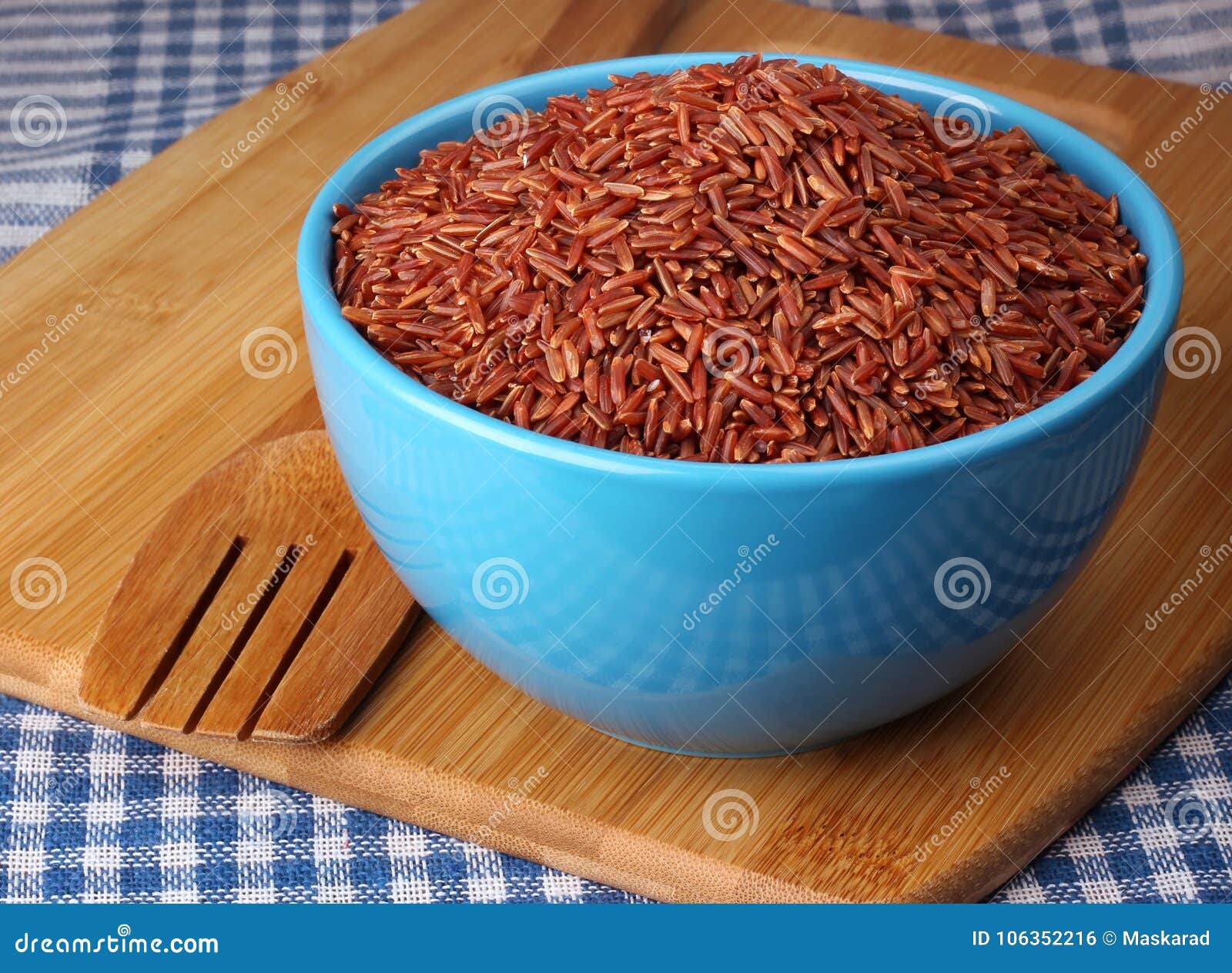 Red rice in the blue bowl. stock photo. Image of seed - 106352216