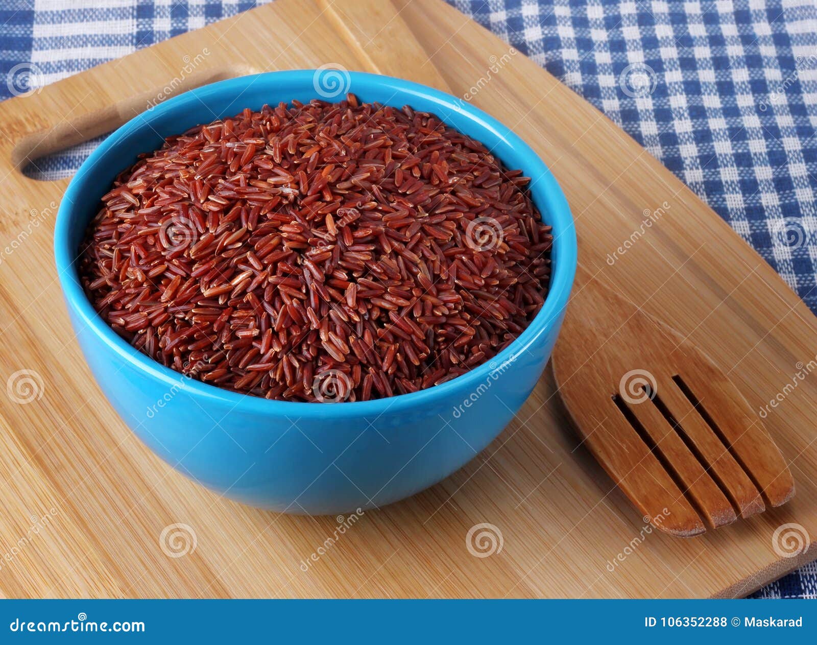 Red rice in the blue bowl. stock photo. Image of seed - 106352288