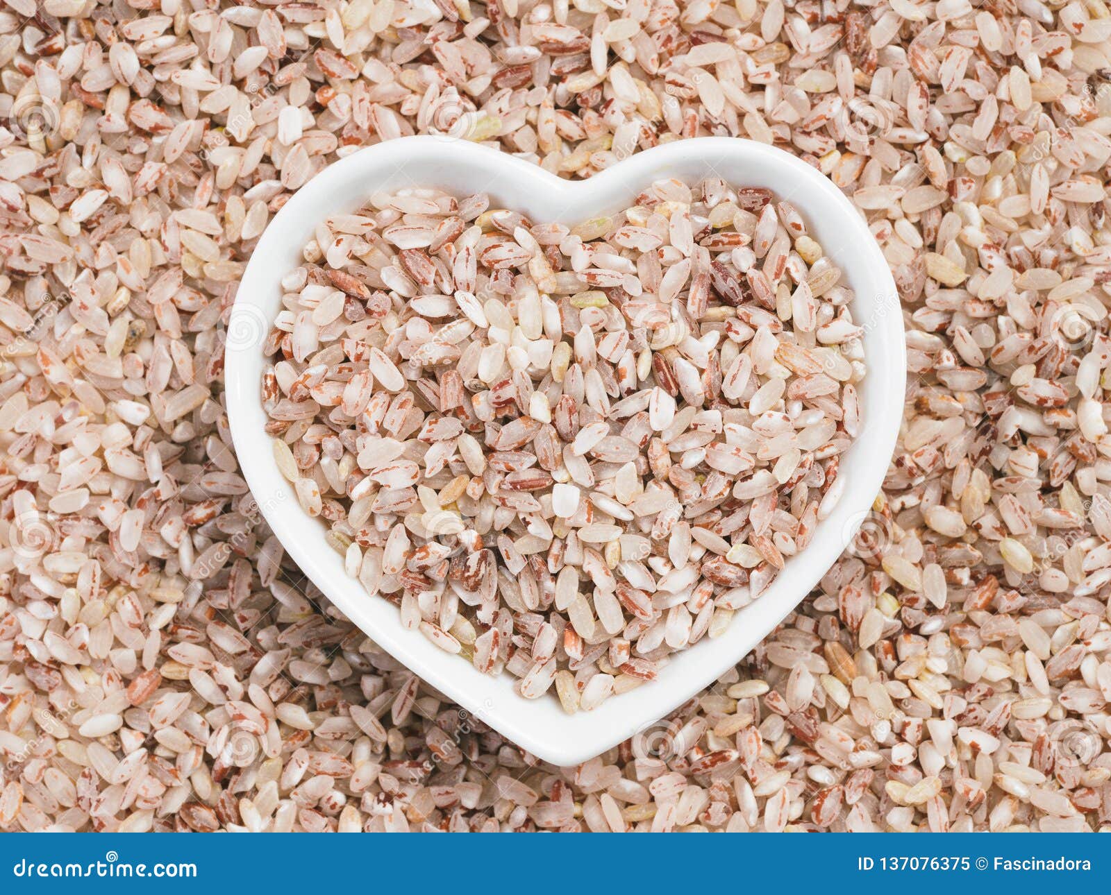 Red Rice in Heart-shaped Bowl on Rice Background Stock Image - Image of ...