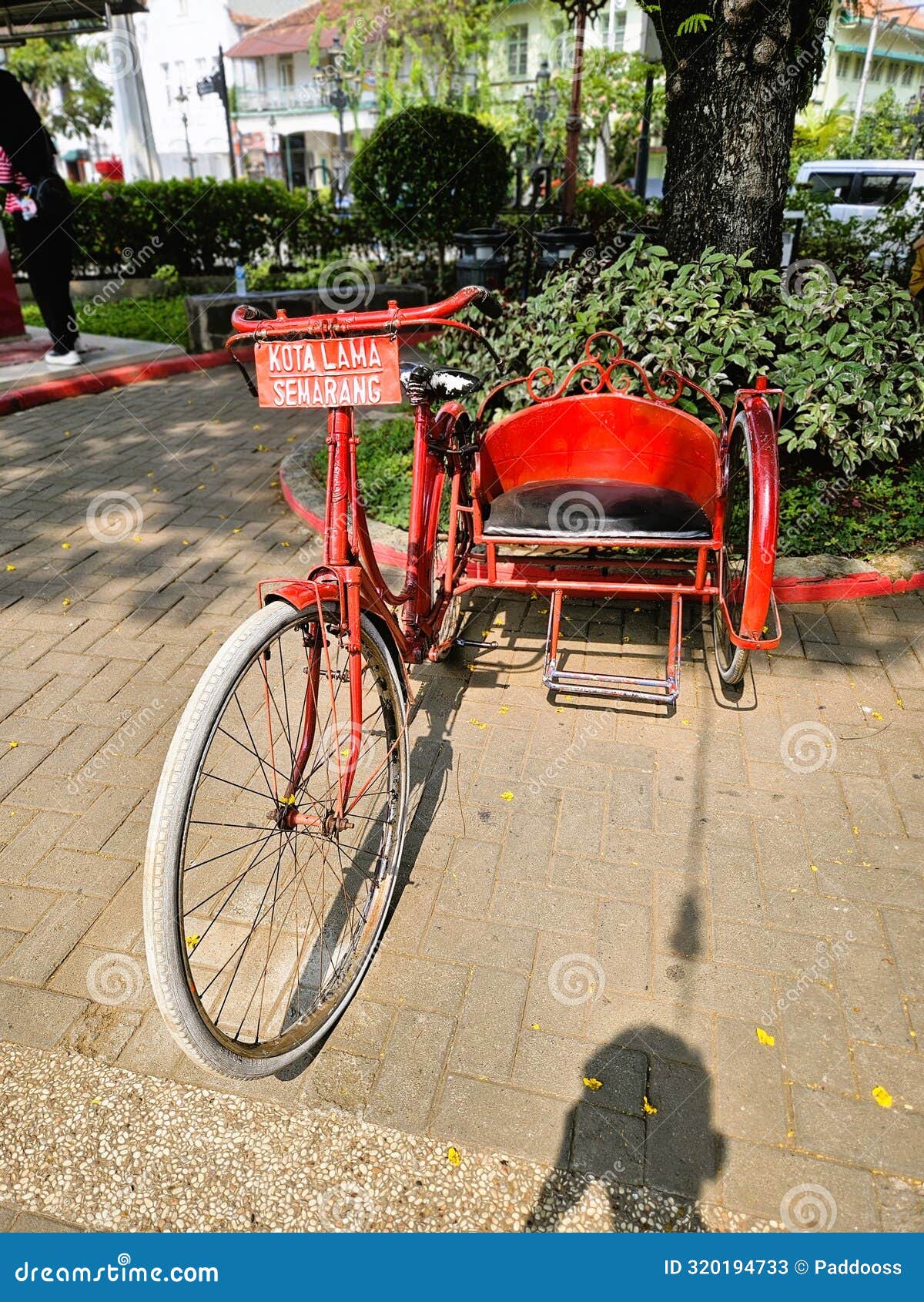 Red rickshaws in the park stock image. Image of ride - 320194733