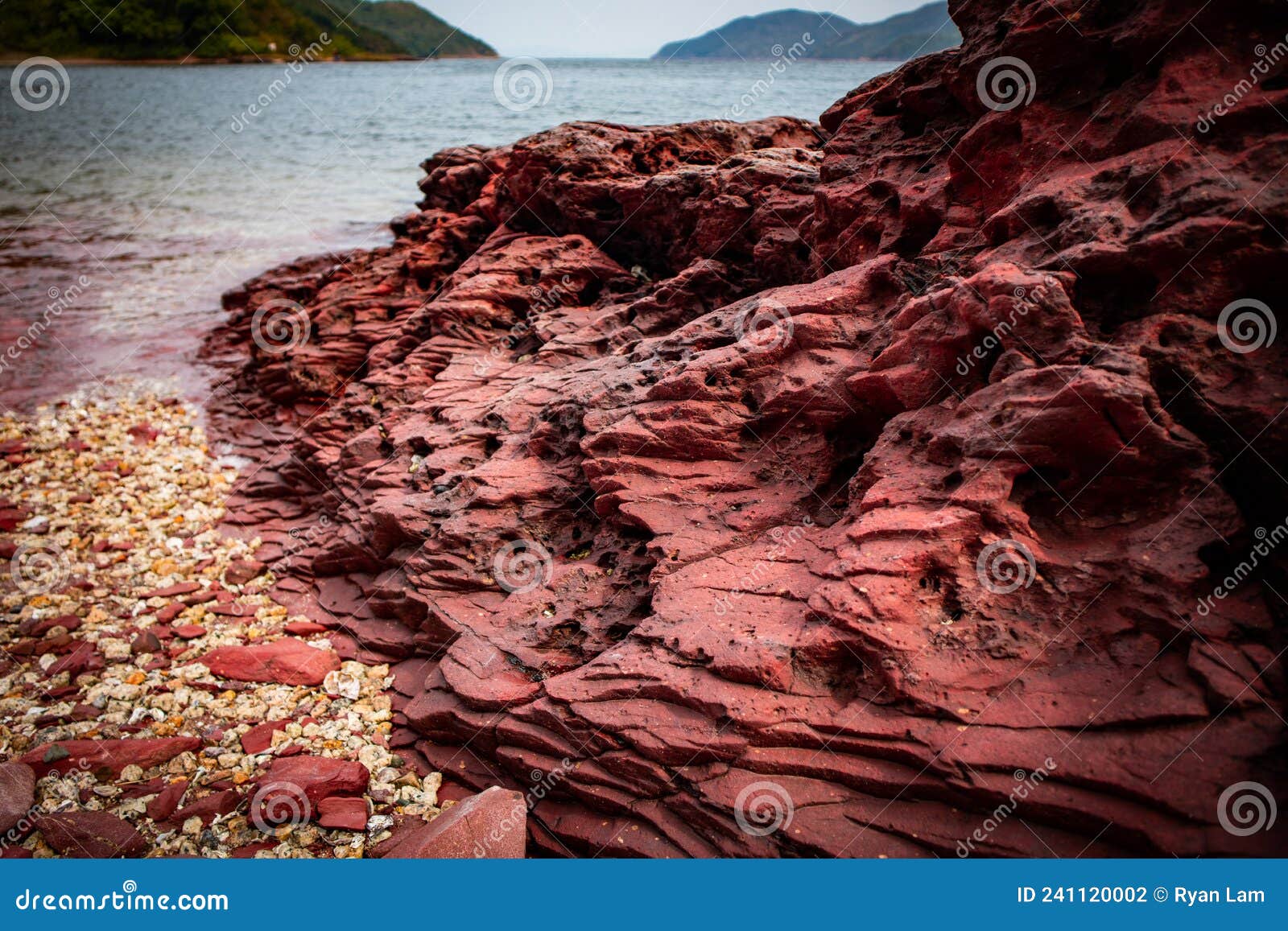 Red rock next to ocean stock photo. Image of landscape - 241120002