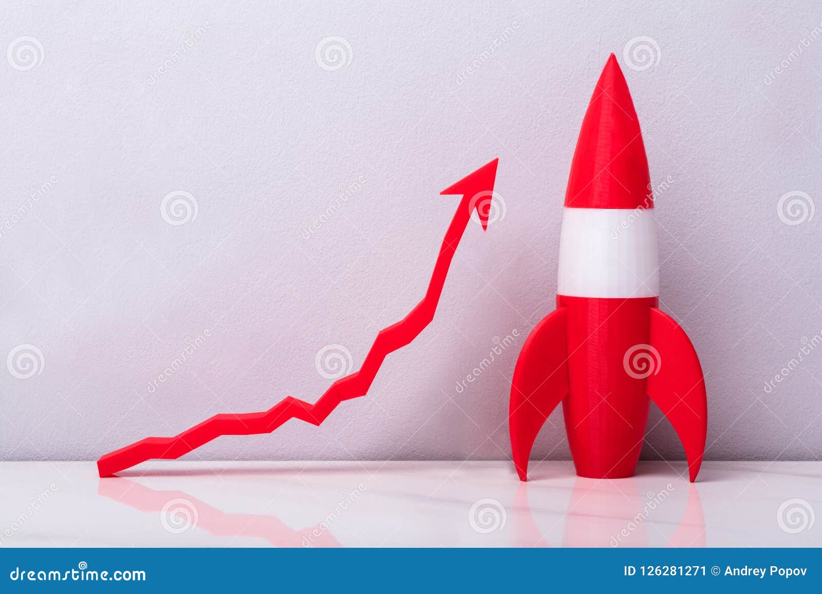 Close-up of Red Rocket beside White Arrow Stock Image - Image of floor ...