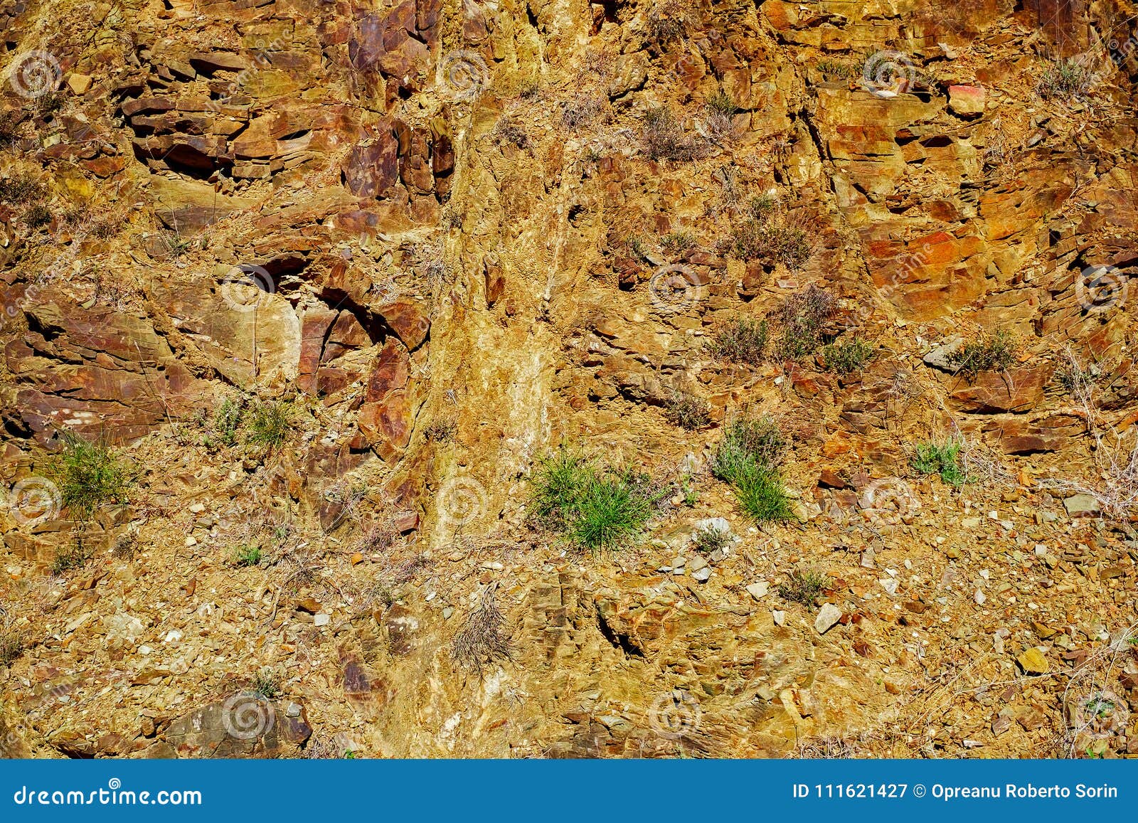 Red rocks with grass stock image. Image of sandstone - 111621427