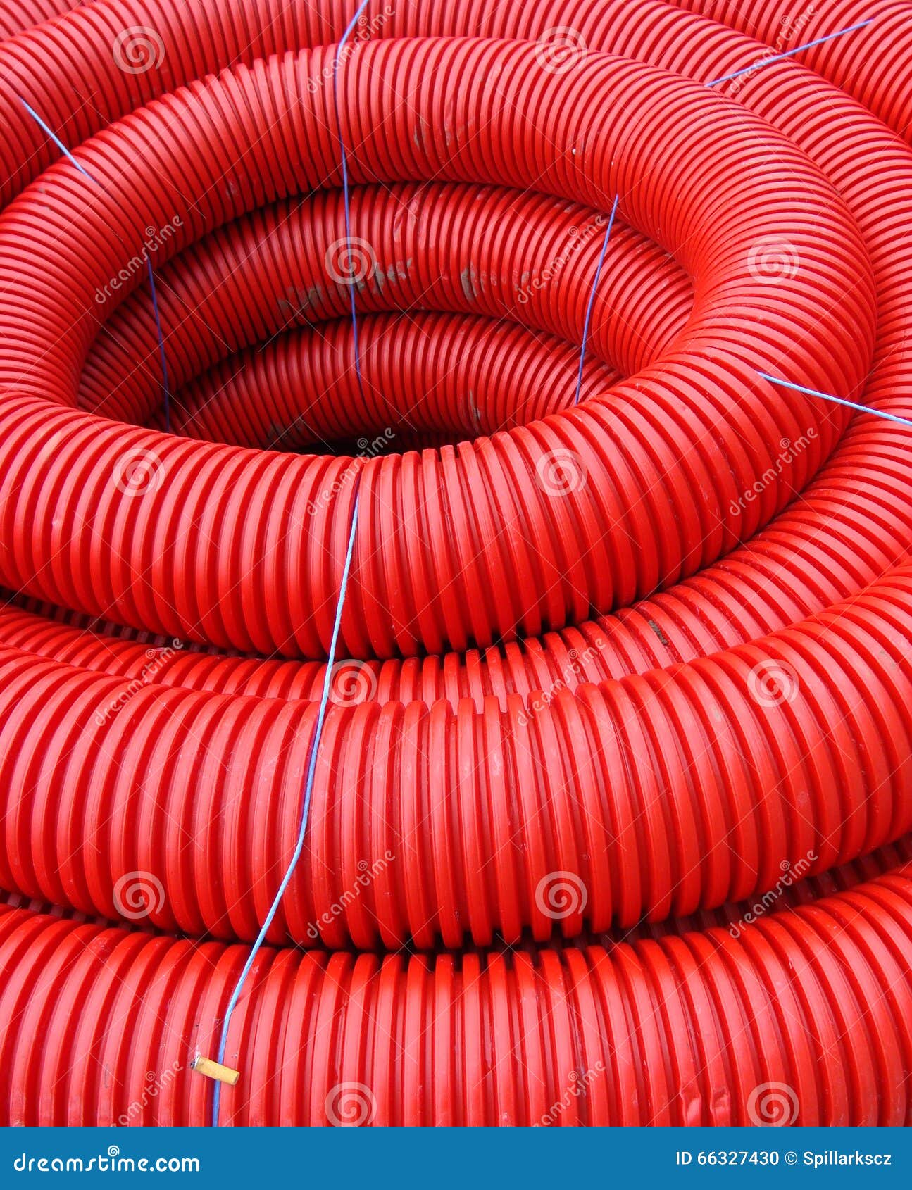 Red Rolled Up Wire Pipe on an Industrial Construction Site Stock Photo ...