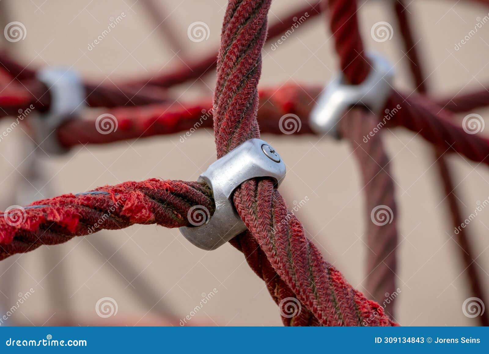 Red Rope Sections Fastened with a Metal Clamp and a Brown Sand ...