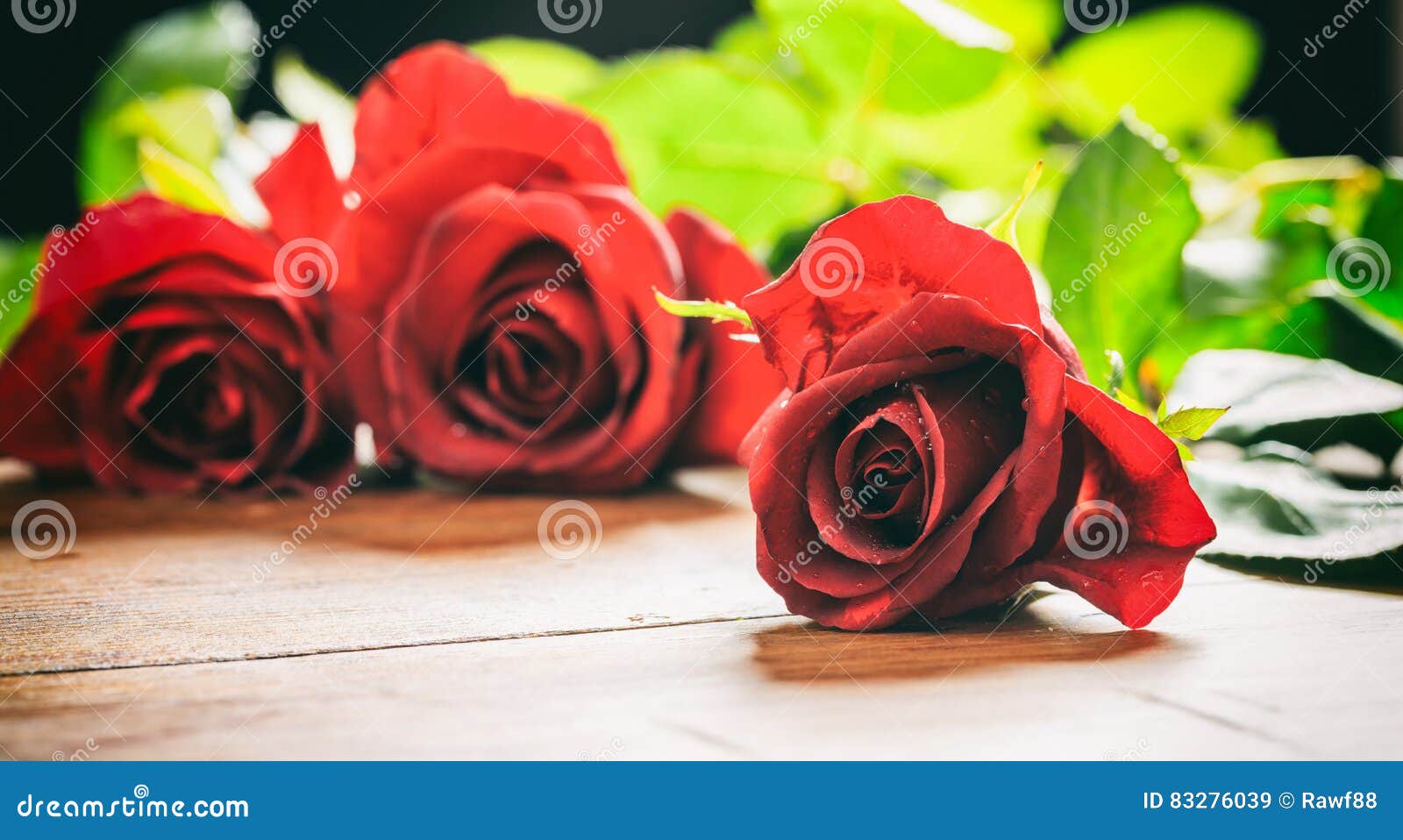 Red roses on wooden table stock image. Image of flora - 83276039