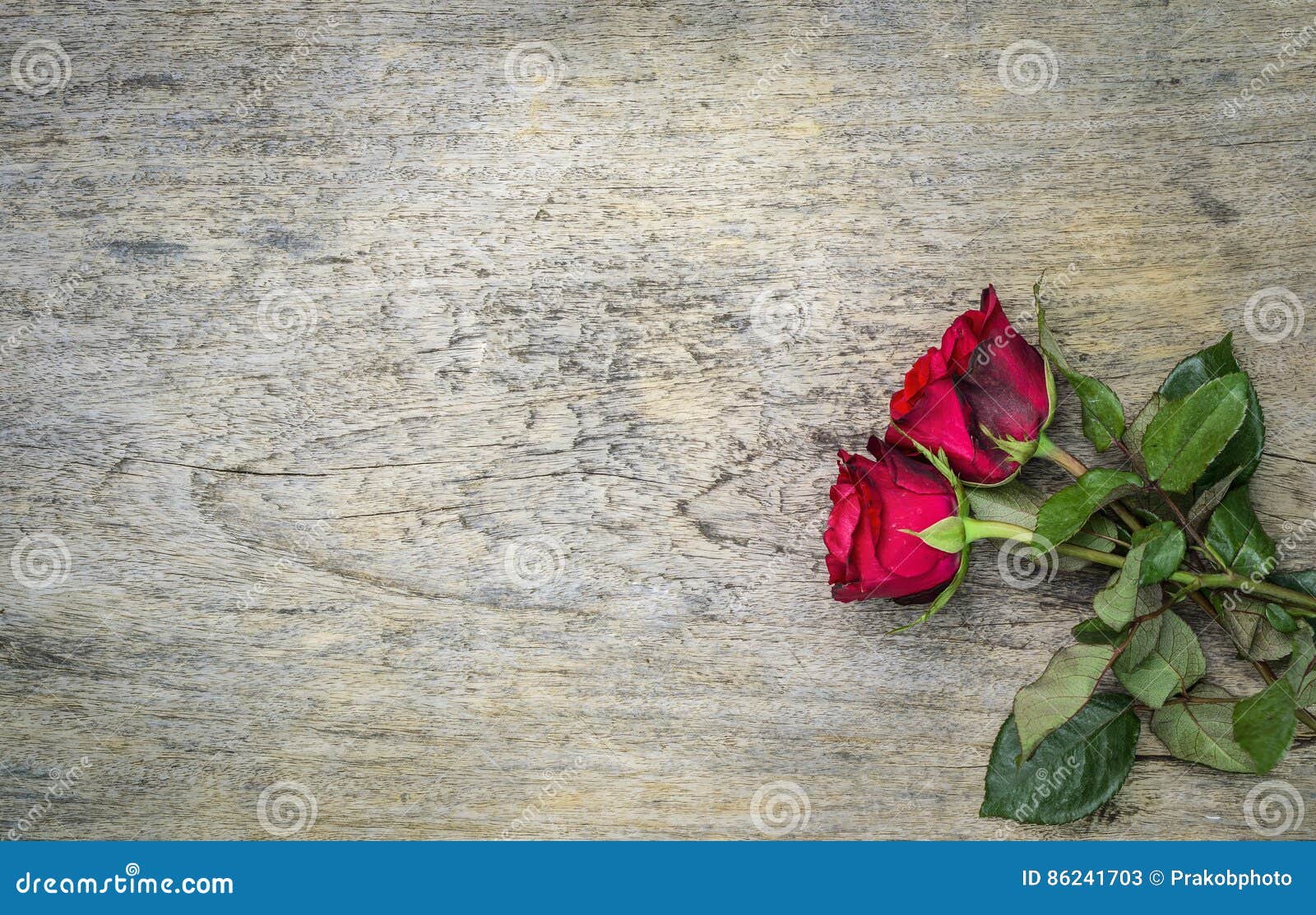 Red roses on wooden table stock image. Image of design - 86241703