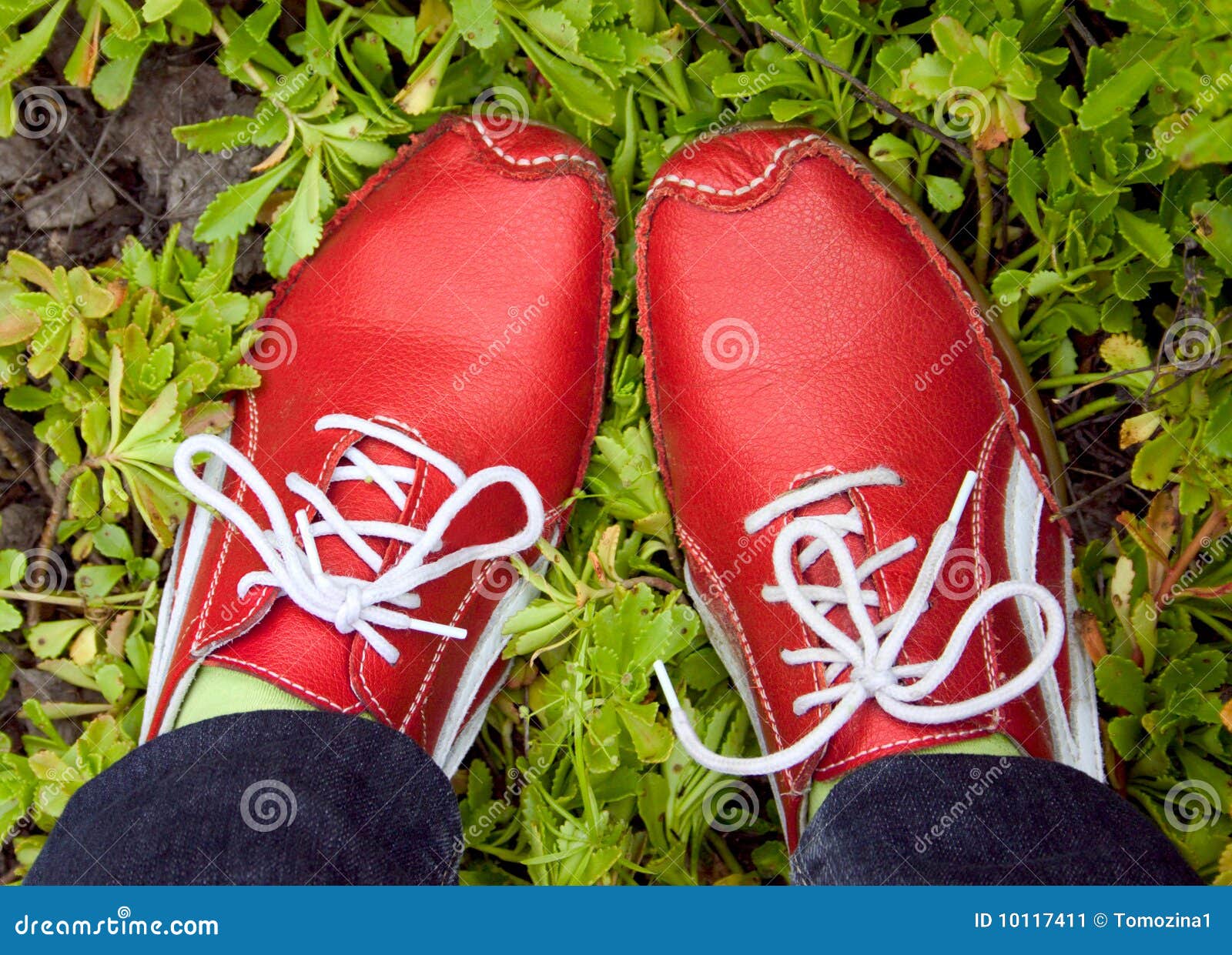 Red Running Shoes on a Grass Stock Image - Image of unconcerned, sport ...