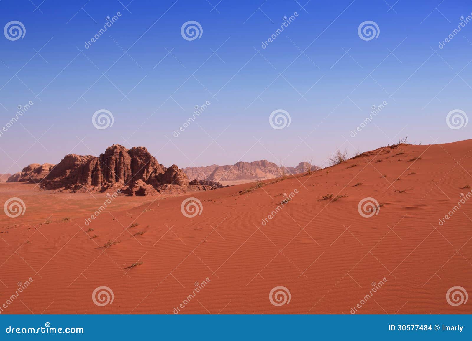 A Red Sand Dune with a Rock Background in Desert Stock Photo - Image of ...