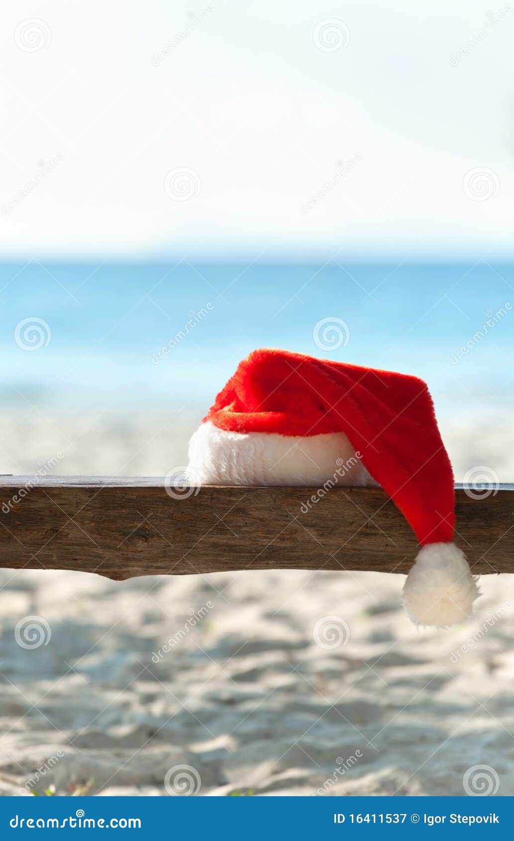 Red Santa S Hat on Wooden Bench on the Beach Stock Image - Image of ...
