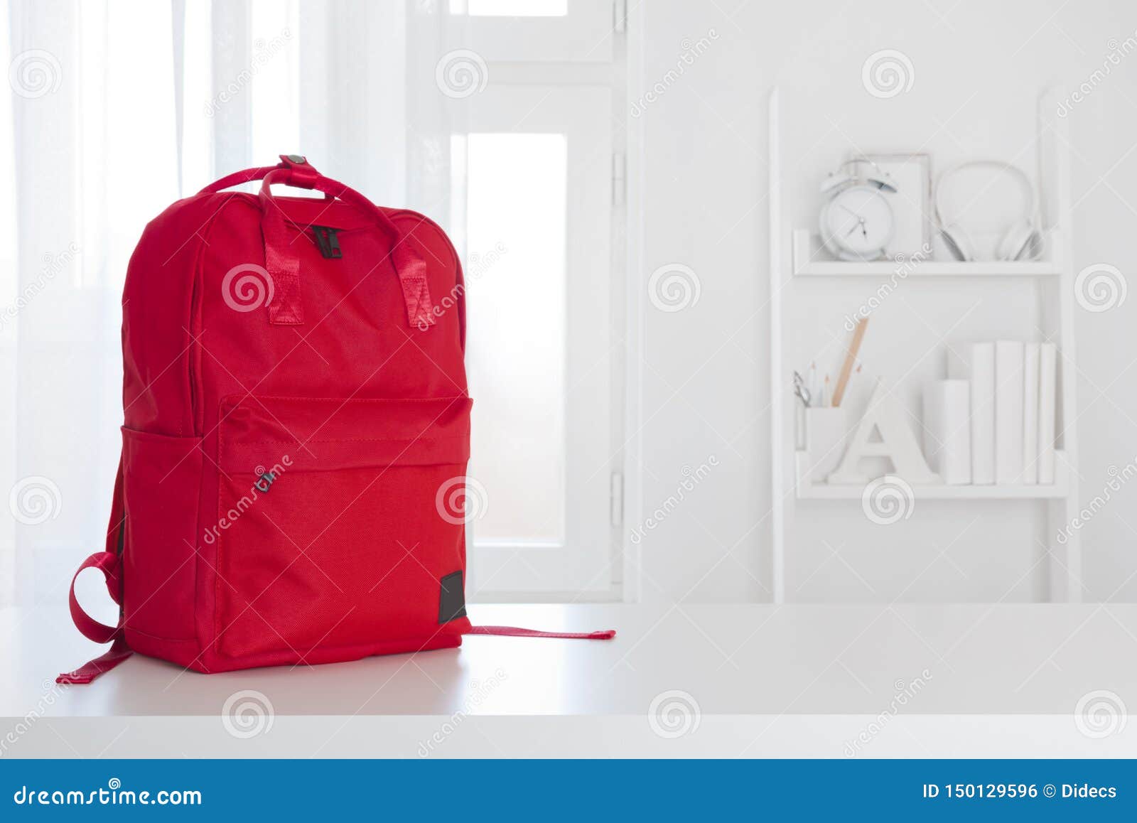 Red School Backpack on Table in Children Room Interior Stock Photo ...