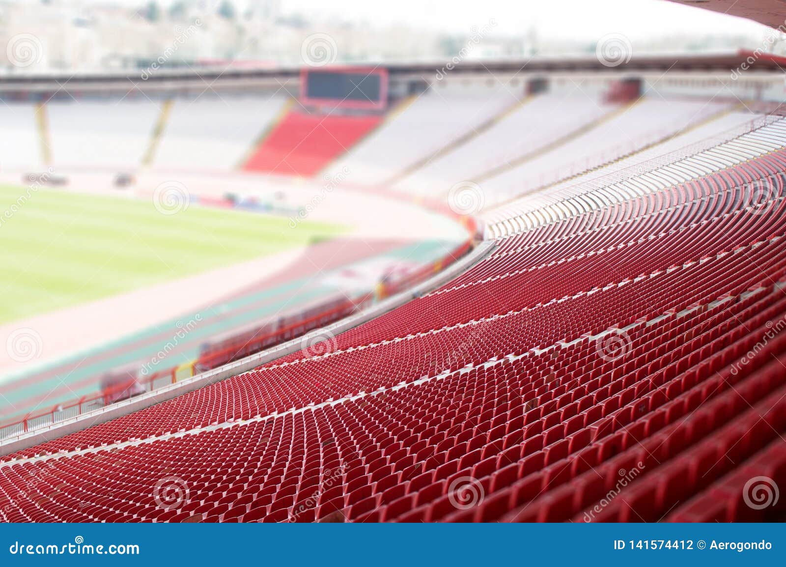 Red seats at the stadium stock photo. Image of field - 141574412