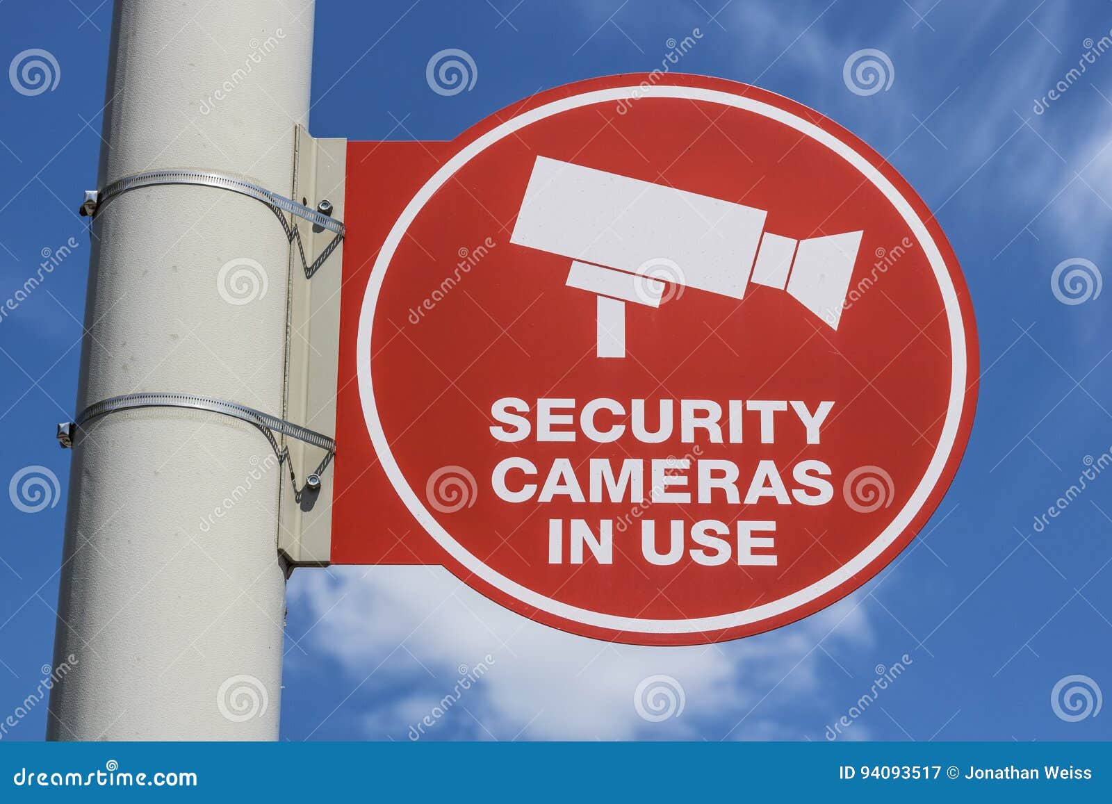 Red Security Camera in Use Sign on Gray Post and Mostly Sunny ...