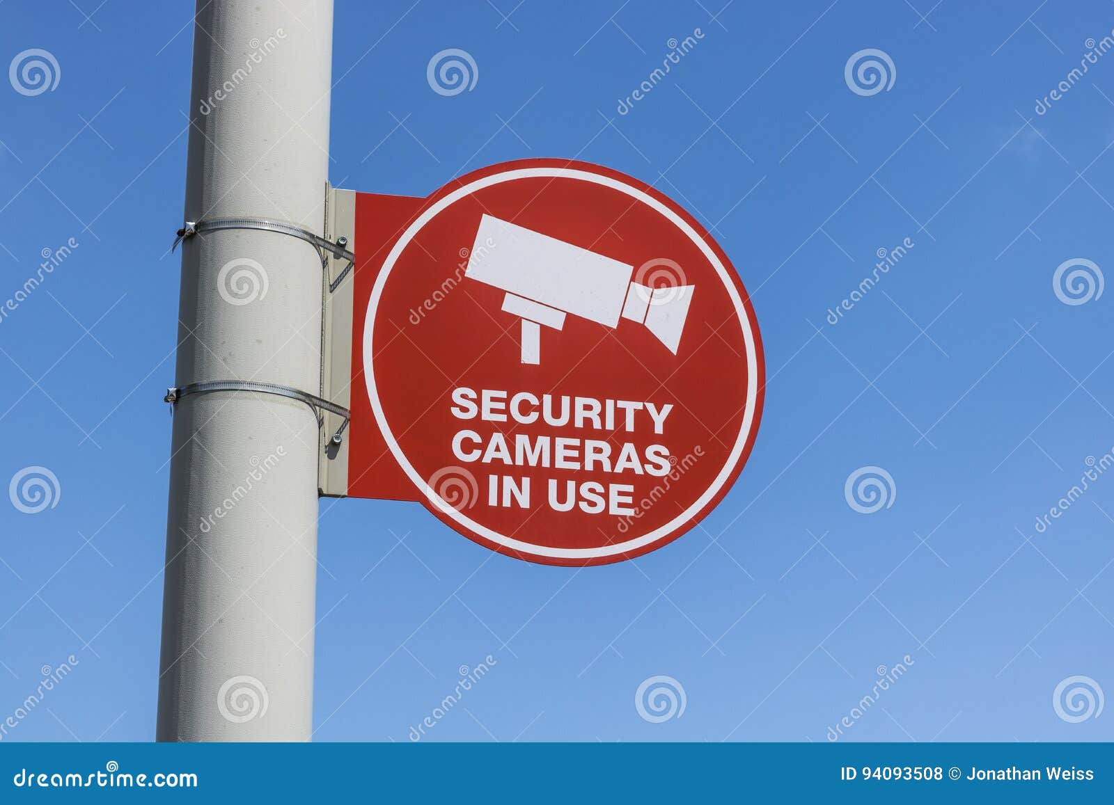 Red Security Camera in Use Sign on Gray Post and Mostly Sunny ...