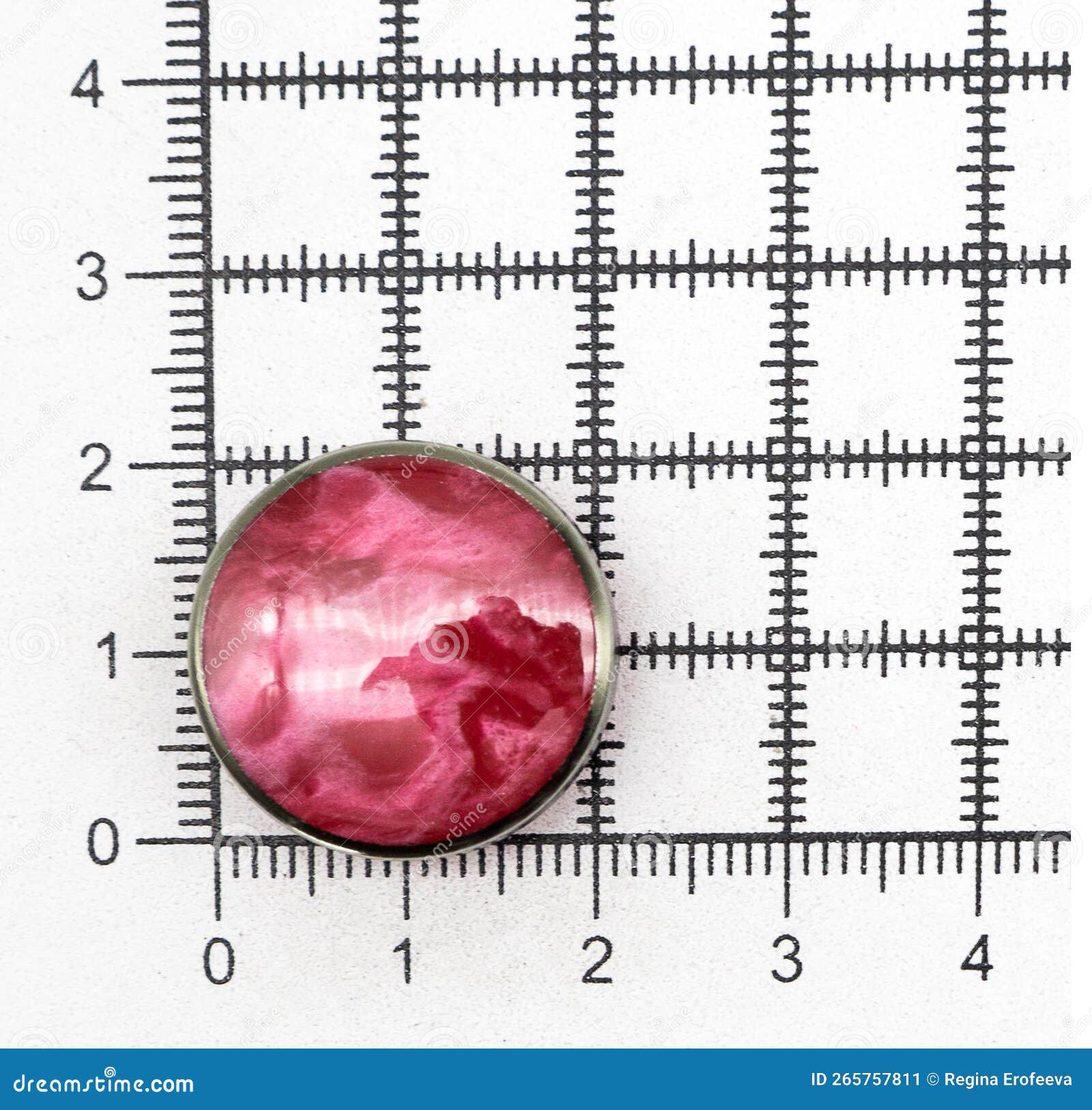 Red Sewing Button with a Beautiful Pattern on a Square Measuring Ruler ...
