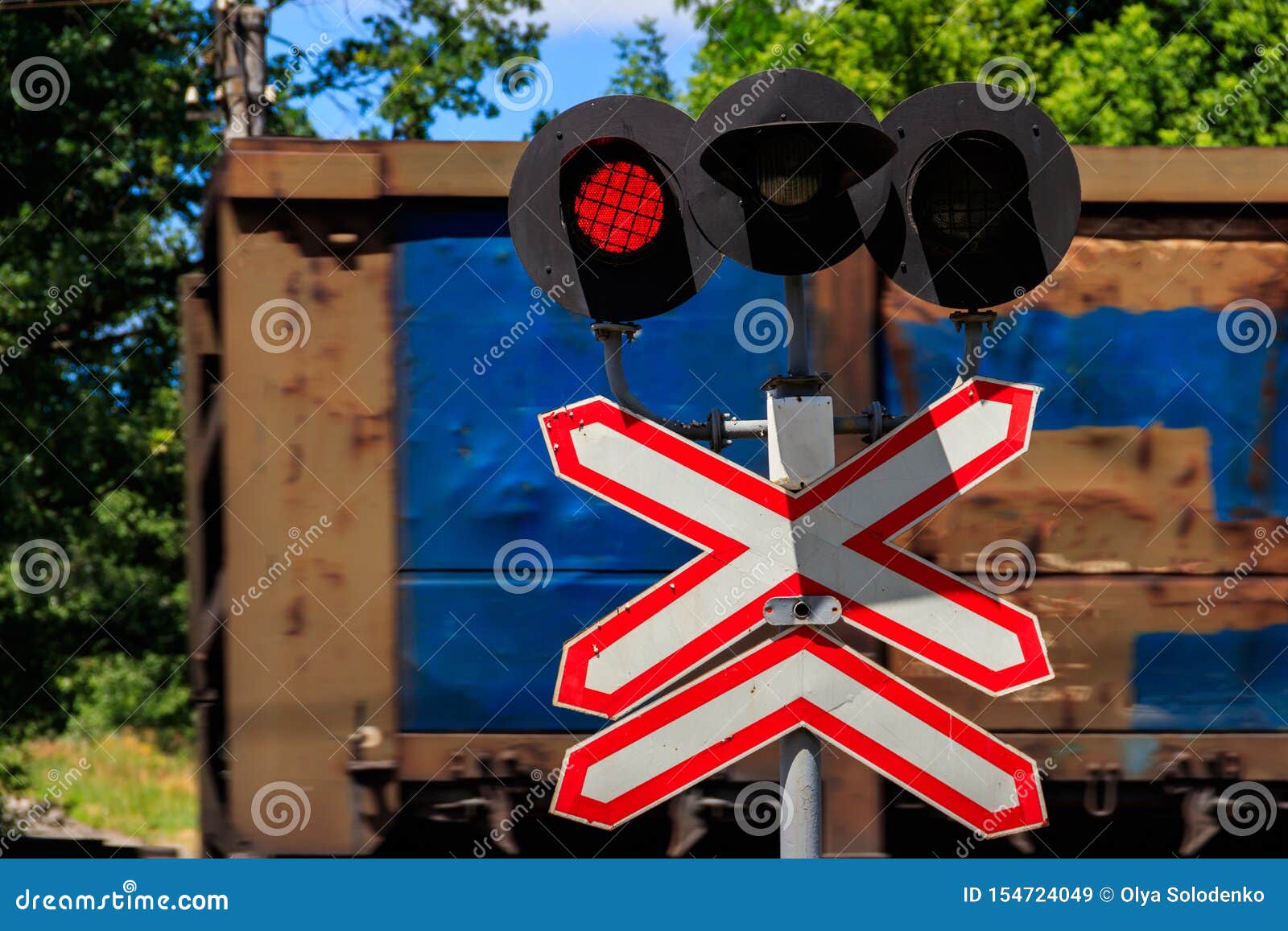 Red Signal of Semaphore and Stop Sign in Front of Railroad Crossing ...