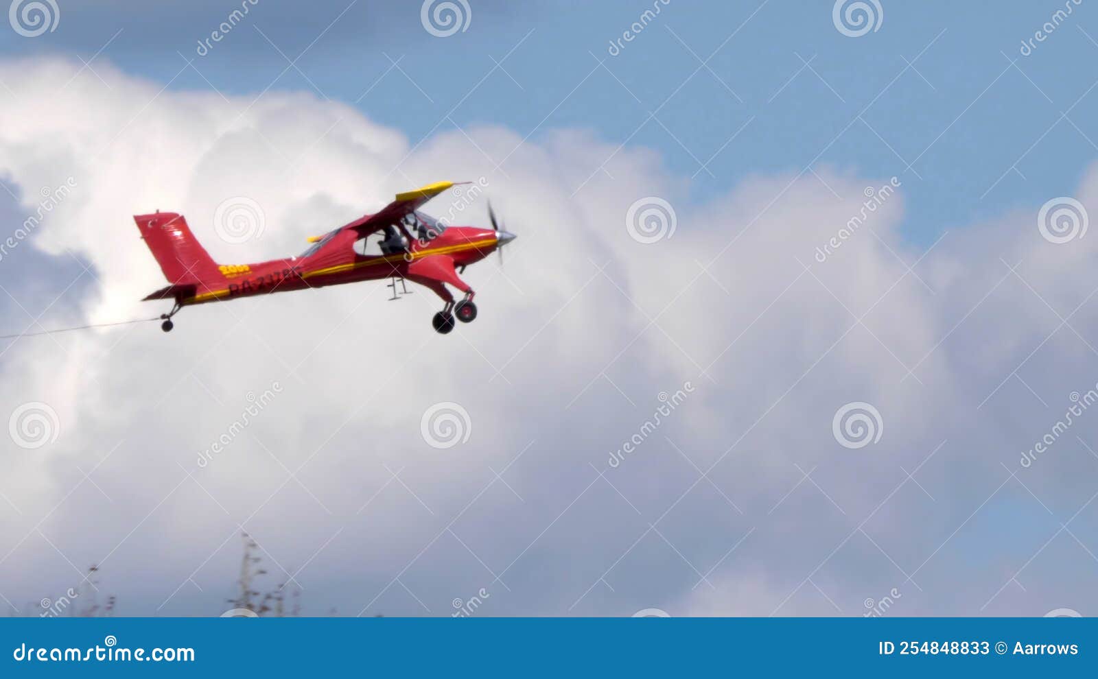 Red Small Sport Plane Flying in the Sky Pulls on a Rope the Glider ...