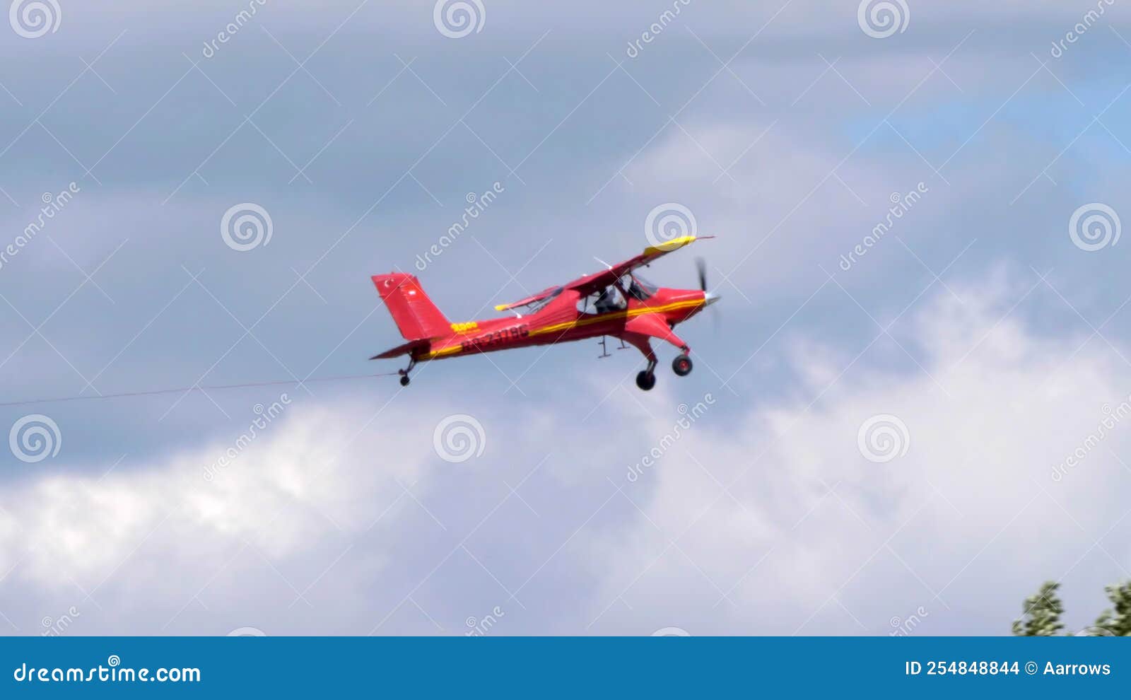 Red Small Sport Plane Flying in the Sky Pulls on a Rope the Glider ...