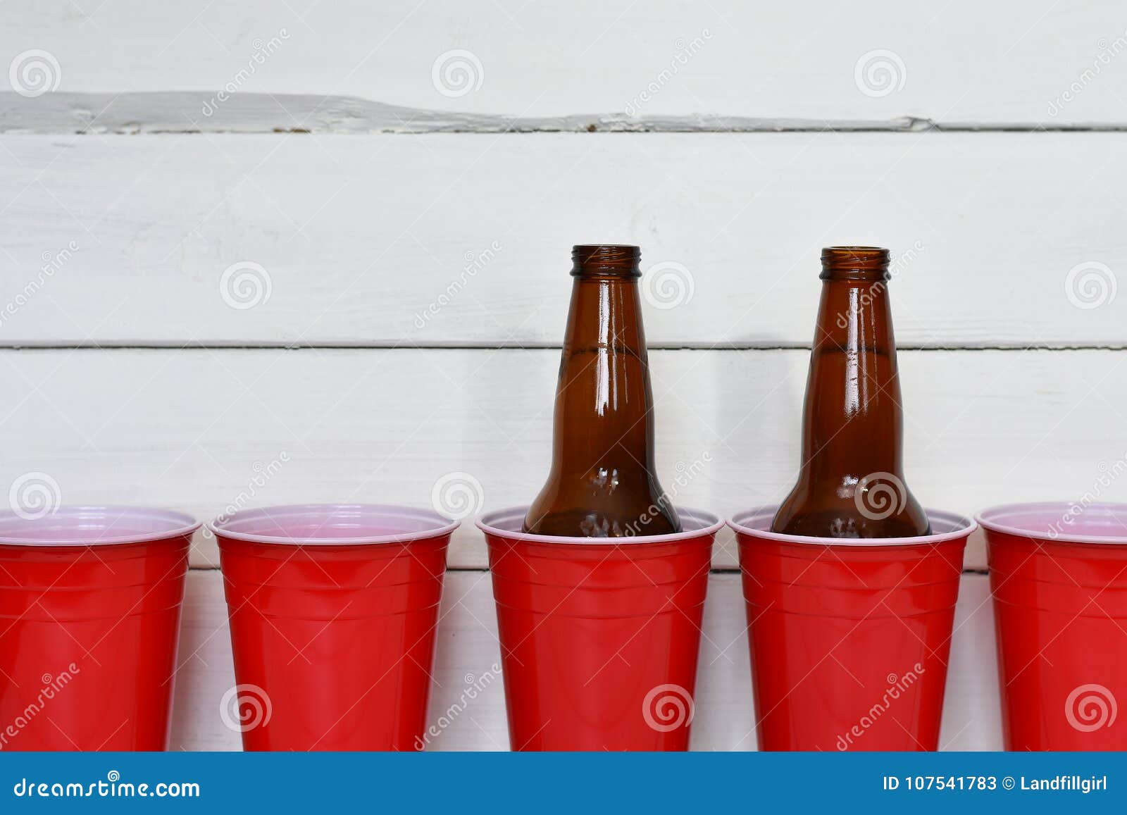 Red Plastic Drinking Cups and Two Beer Bottles Stock Image - Image of ...