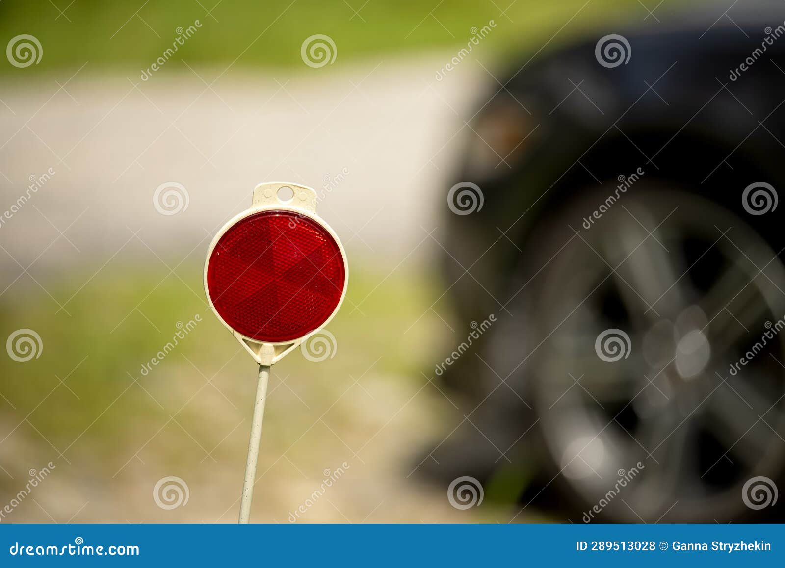 Red STOP Sign Reflector and Blurred Image of a Car Stock Photo - Image ...